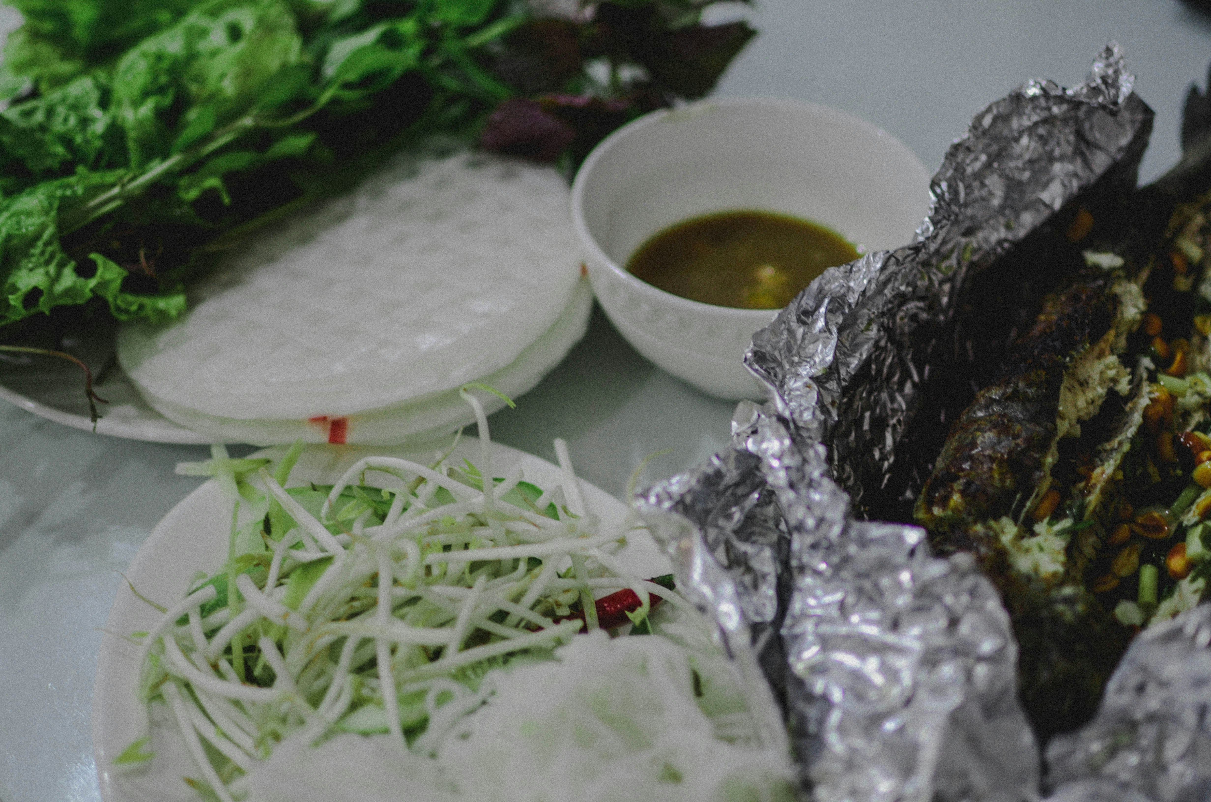 Foil-Wrapped Ember Bite Amid Crisp Daikon and Greens