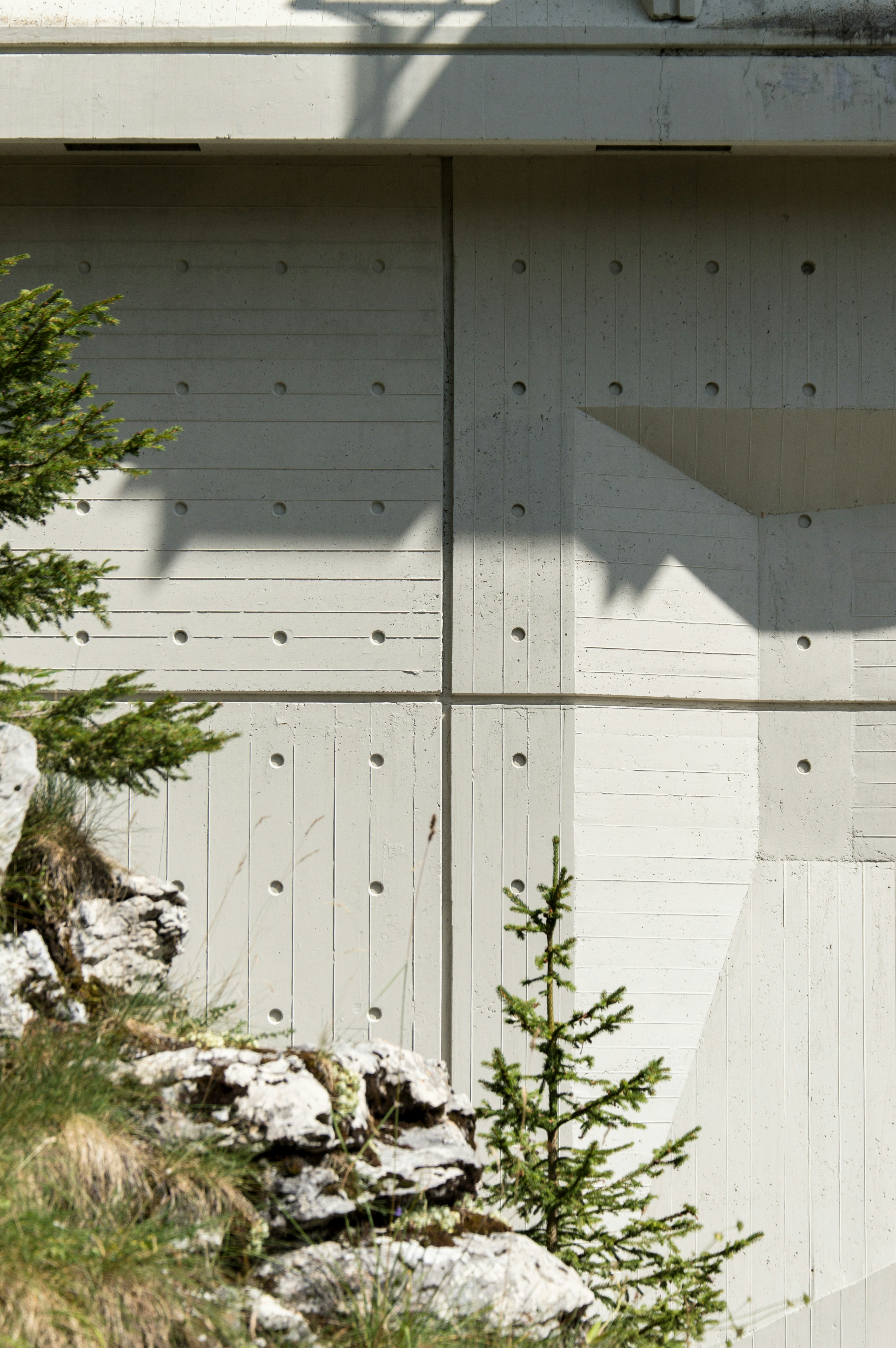 Gridline Shadows on a Mountain Concrete Facade
