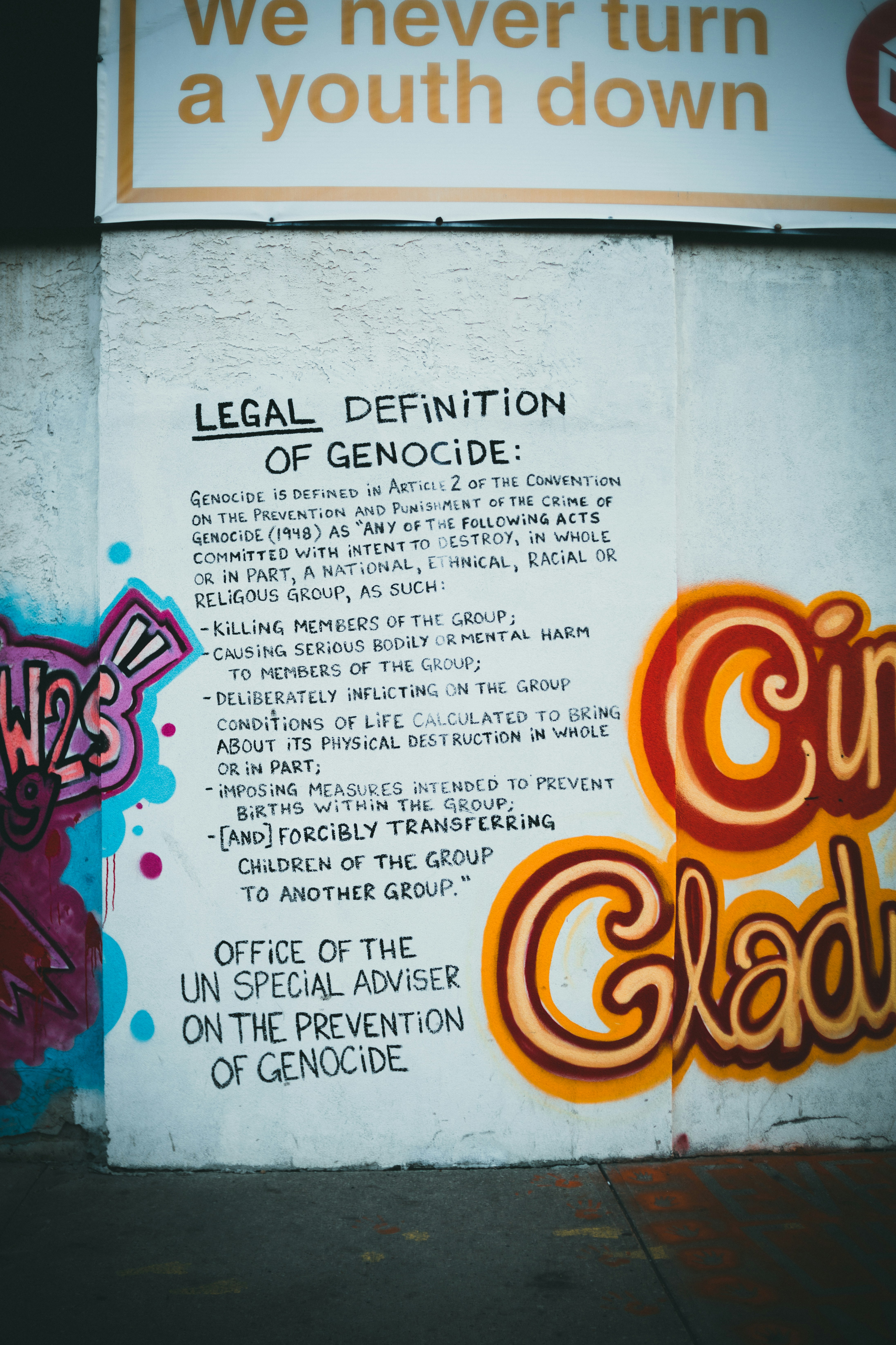 Graffiti on the side of a building that says legal definition of ...