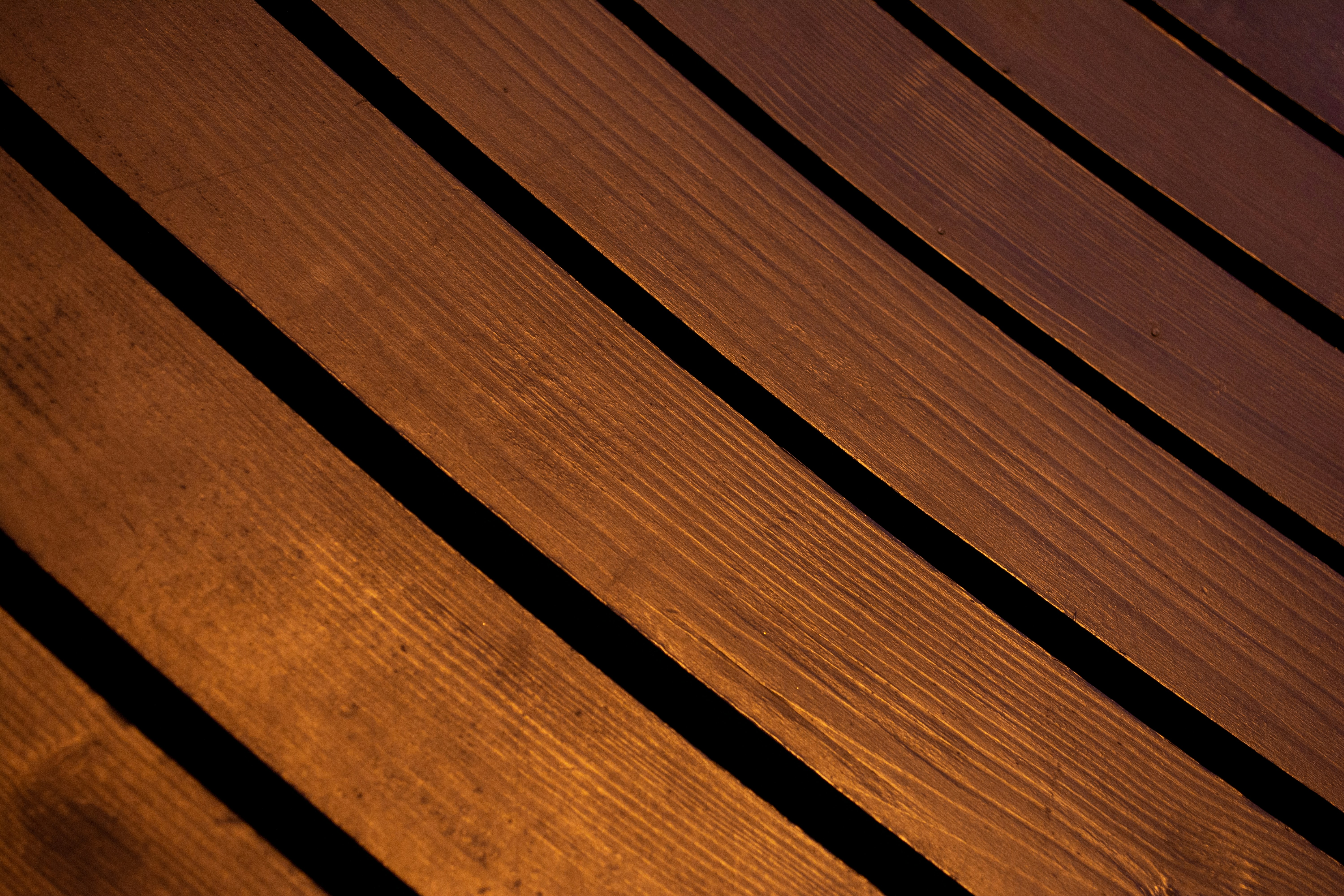 Close-up view of wooden planks arranged in a curved pattern, showcasing rich textures and warm tones.