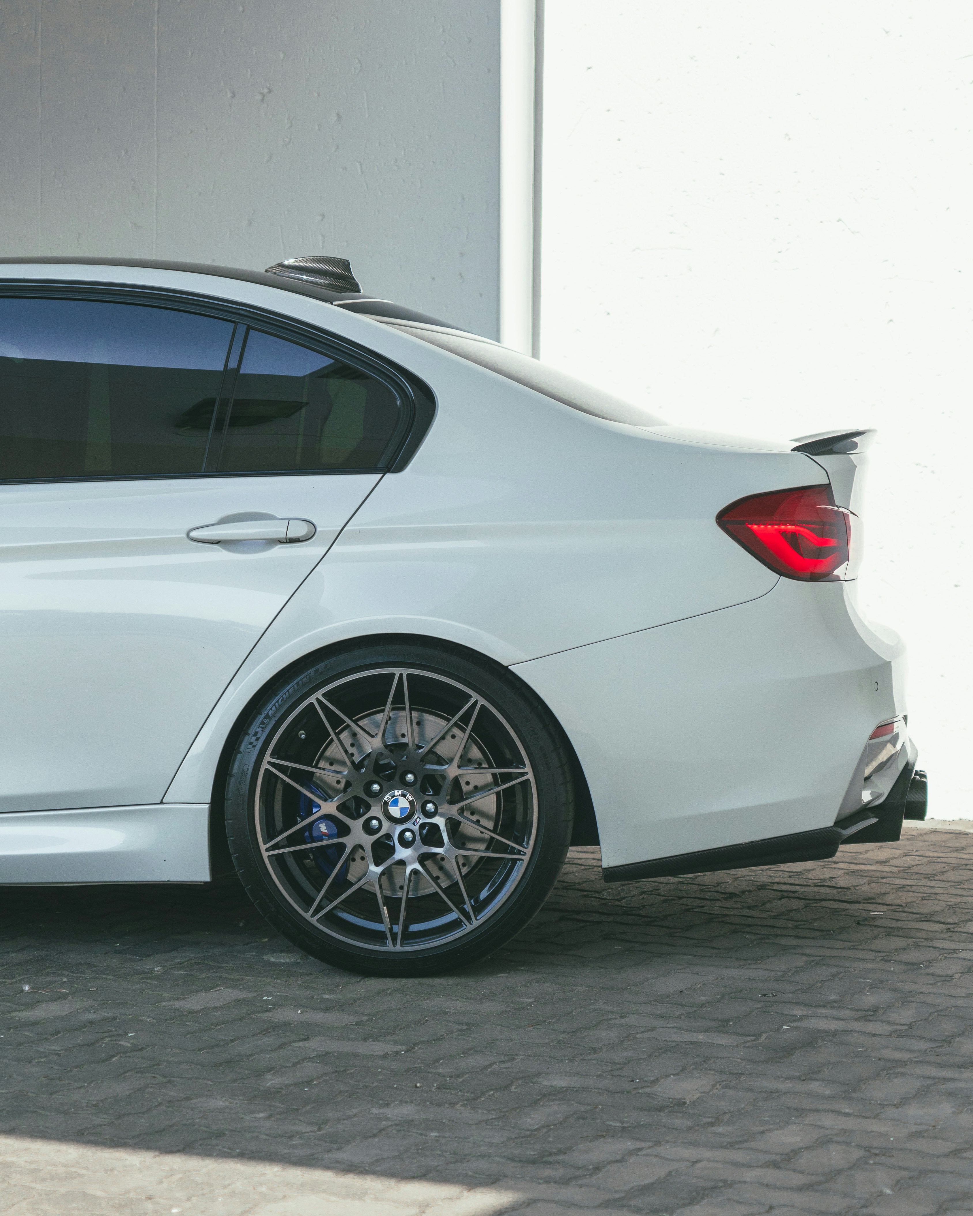 A white car parked in front of a building photo – Free Car Image on ...