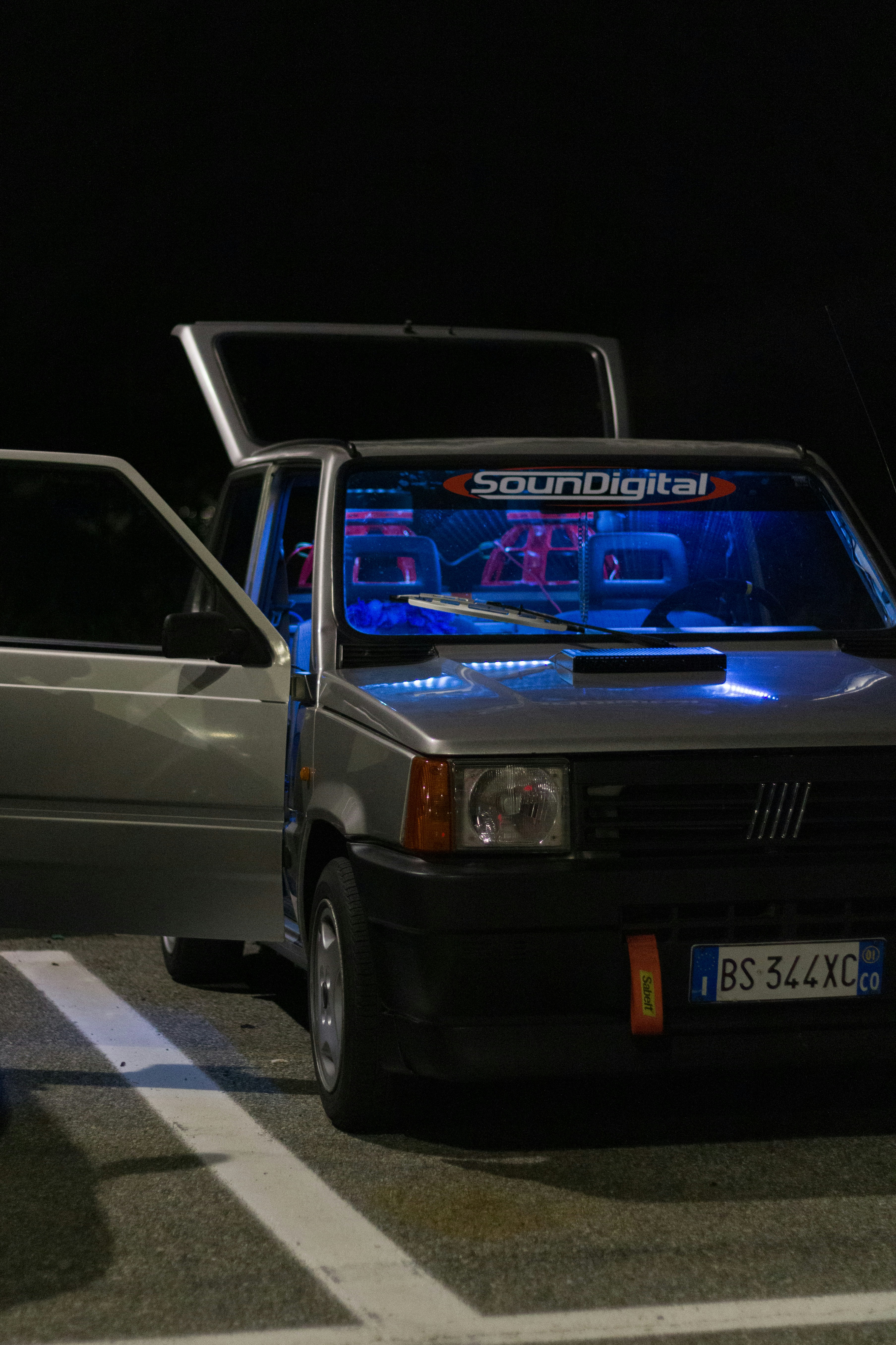 a car parked in a parking lot at night