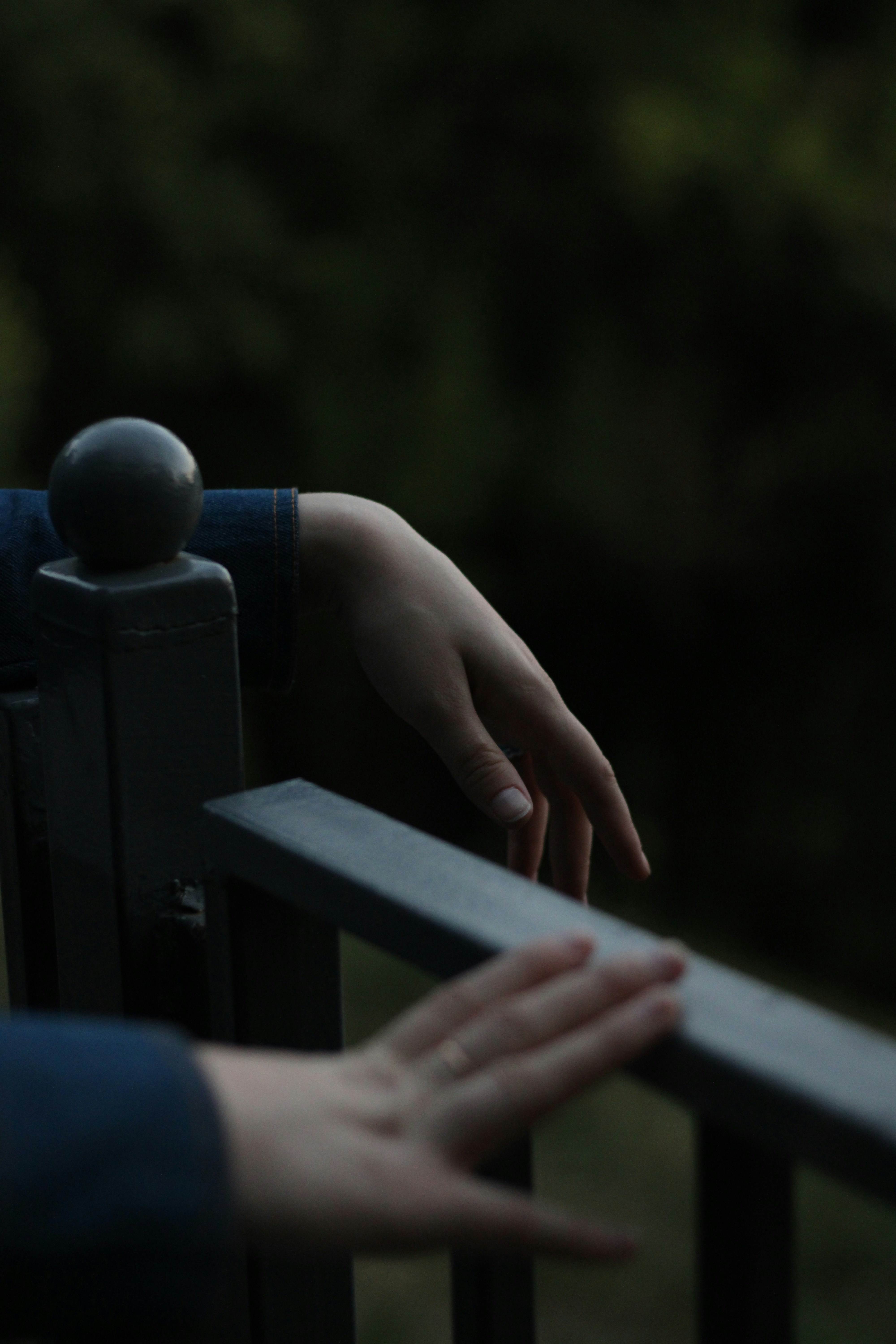 A hand reaching over a railing towards a person's hand photo – Free ...