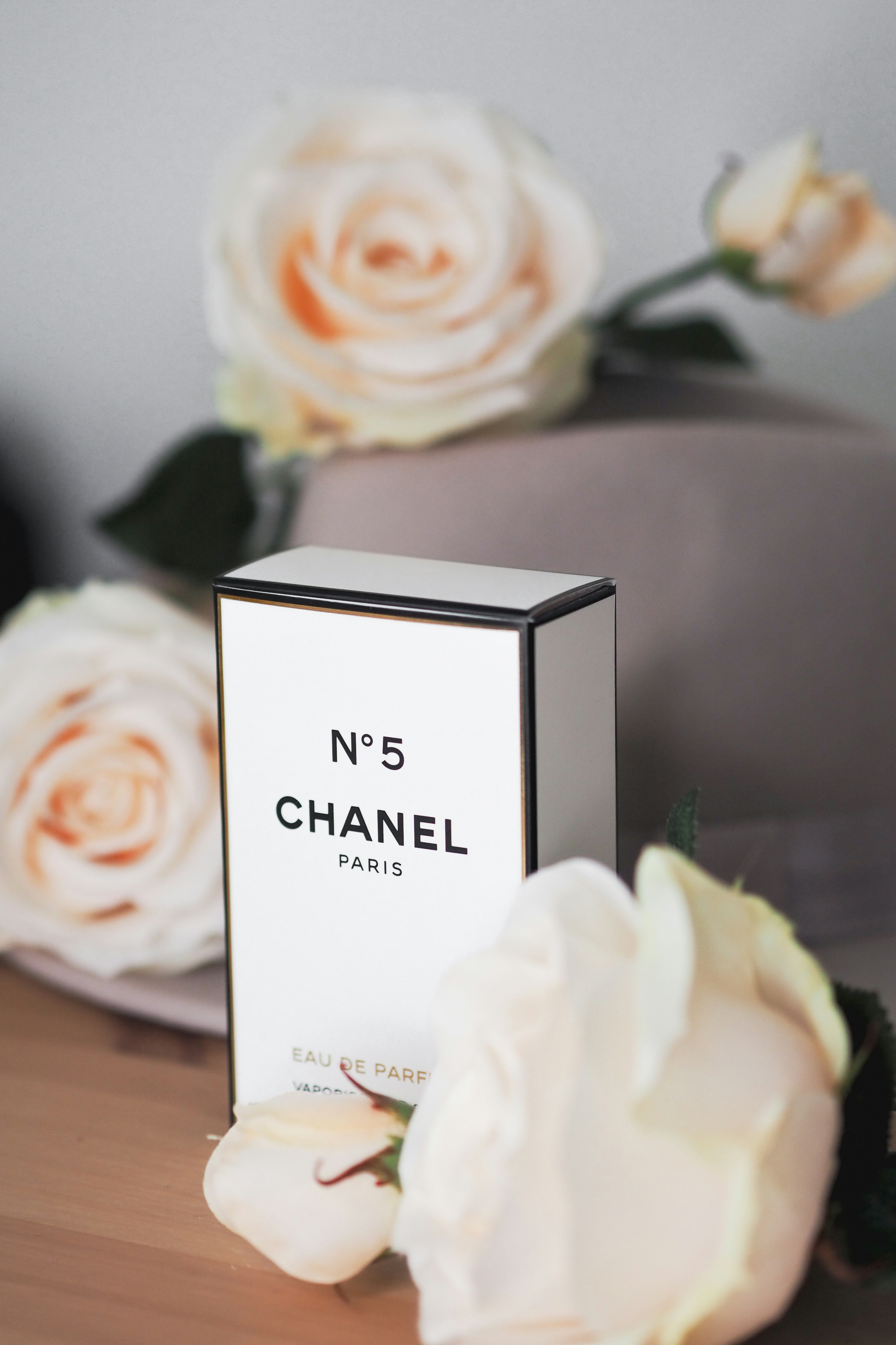 A box of chanel perfume sitting on top of a table photo – Free Grey ...