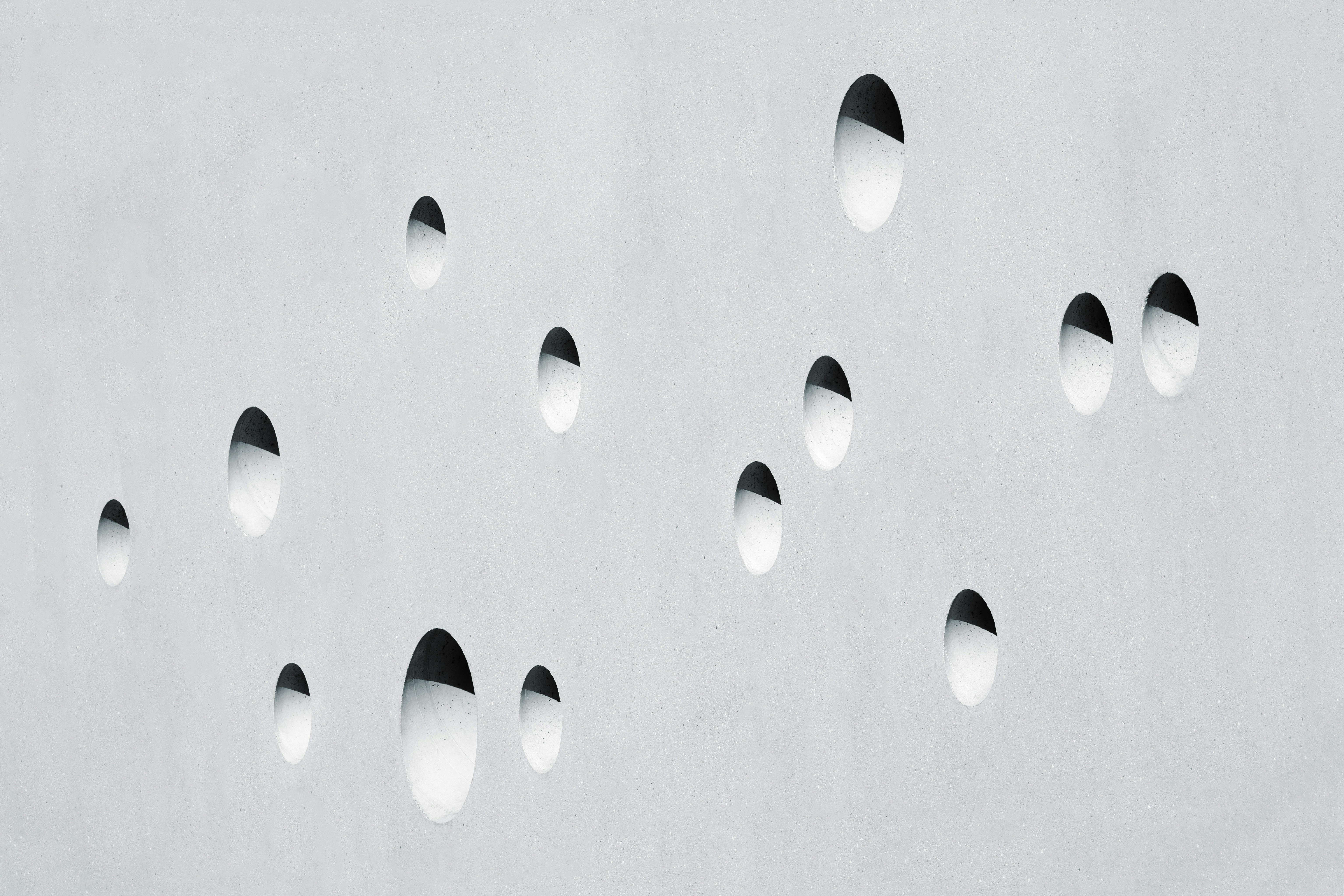 a white wall with a bunch of holes in it