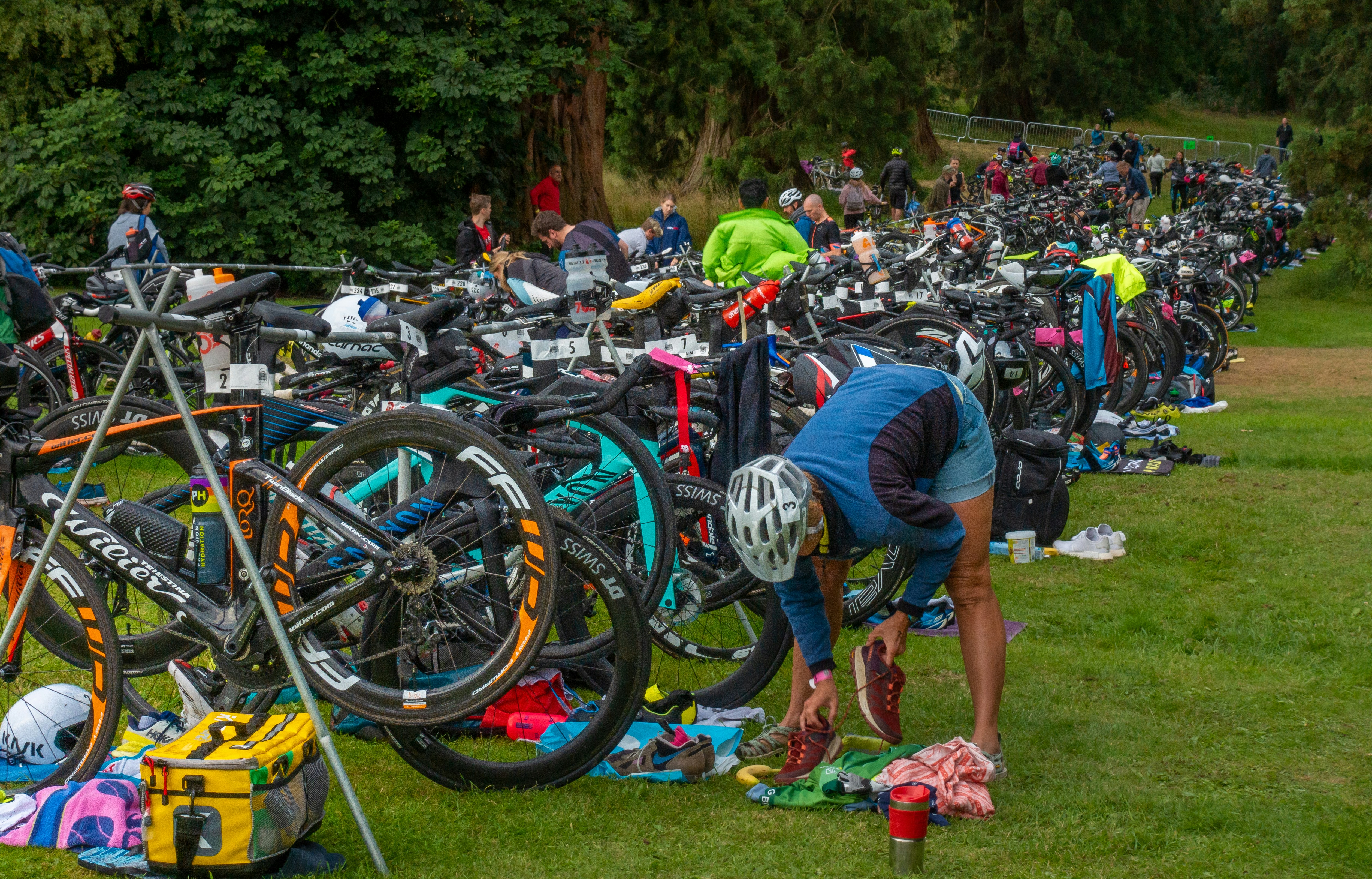 a group of people standing next to a bunch of bikes