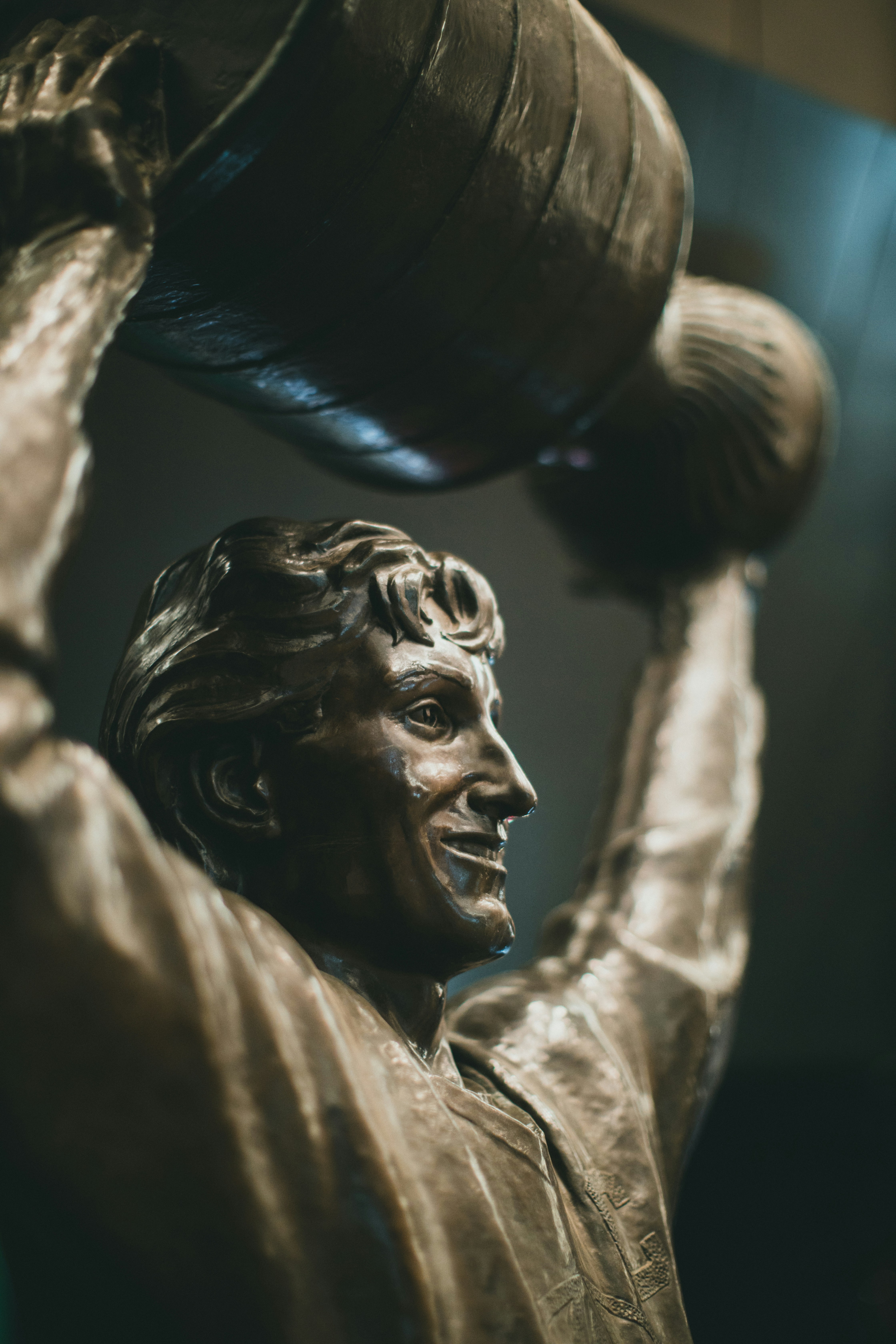a statue of a man lifting a bucket
