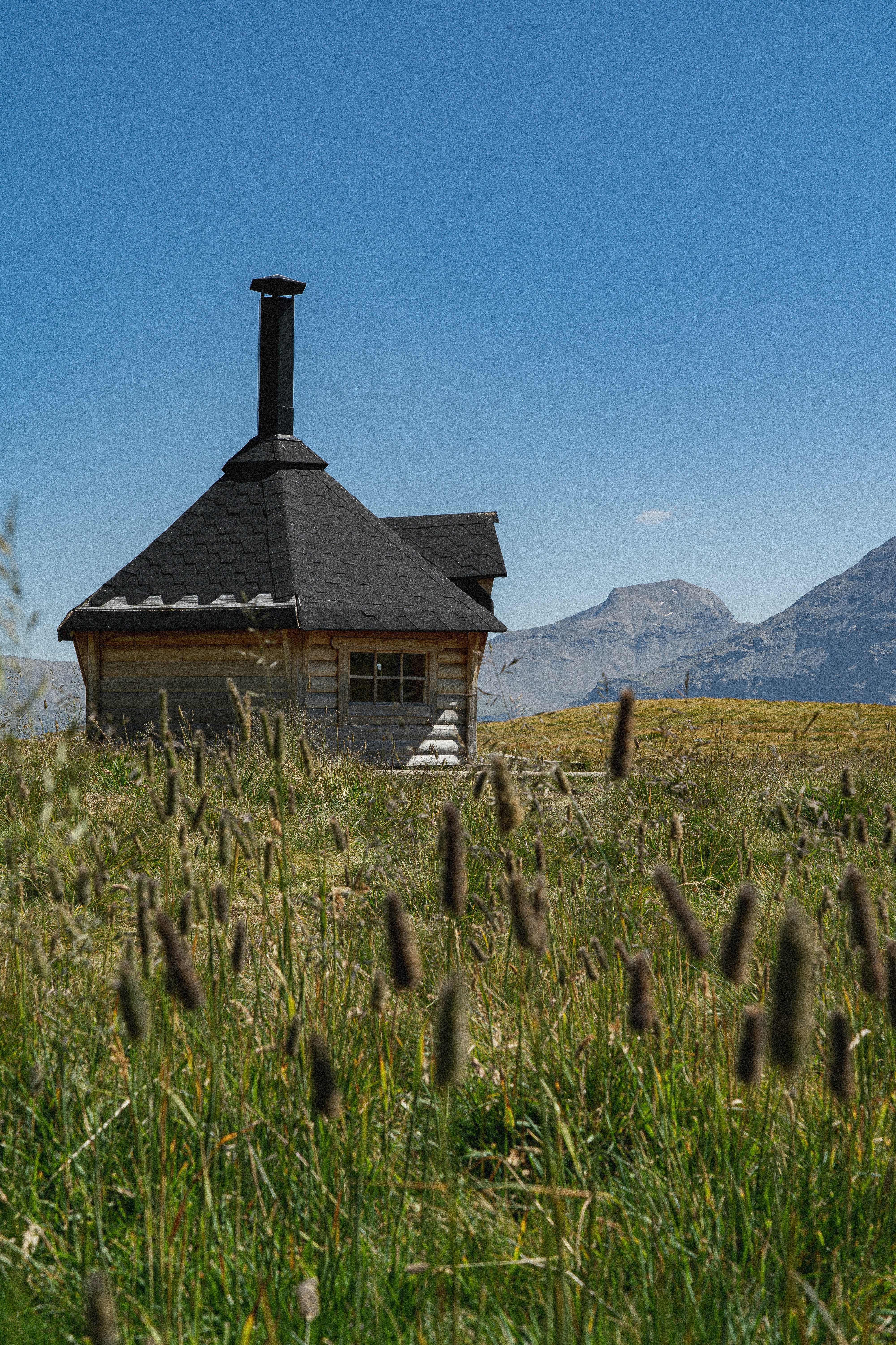 Hilltop cabin under a sapphire sky