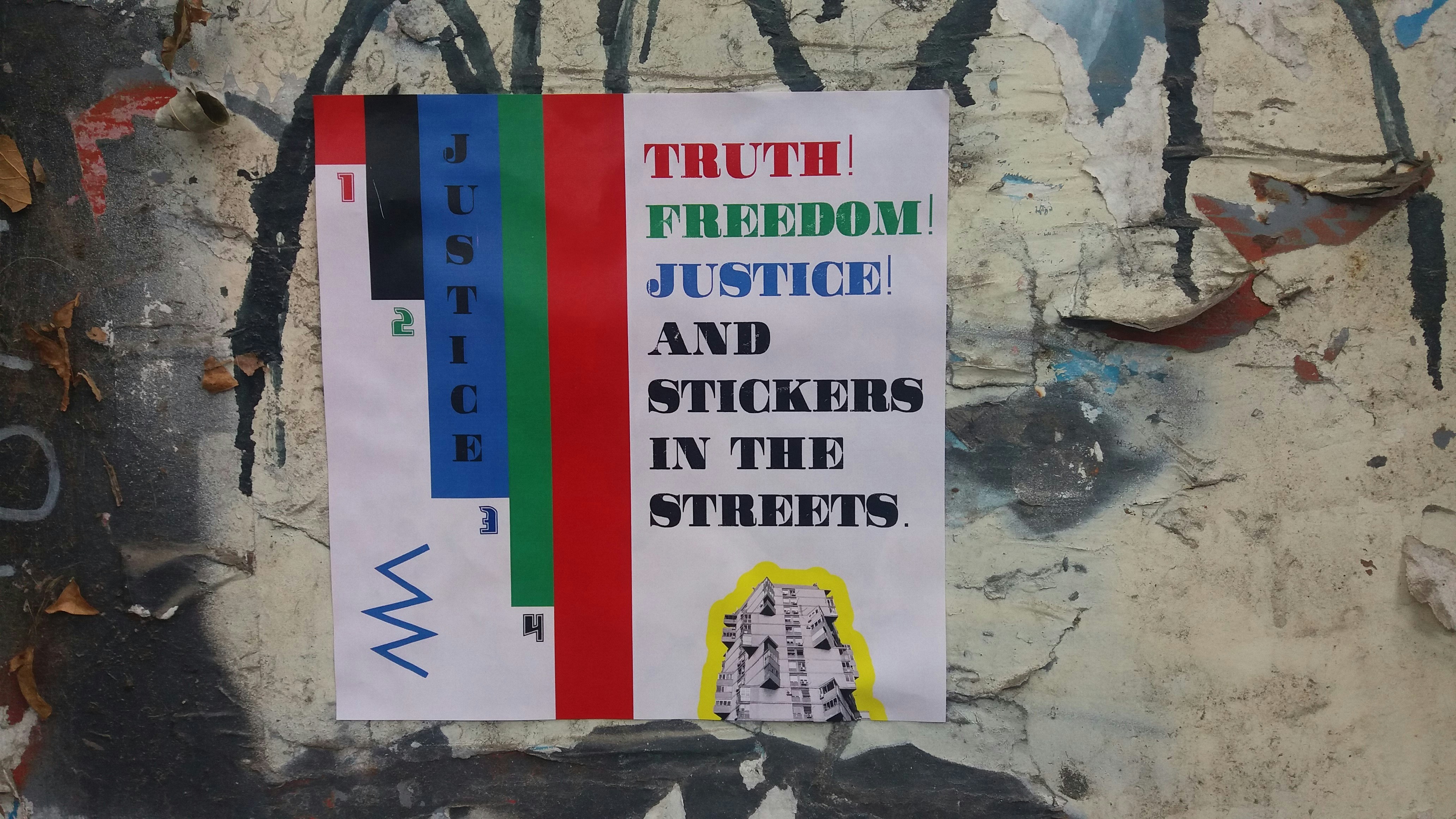 A poster on the side of a building that says truth freedom justice and ...