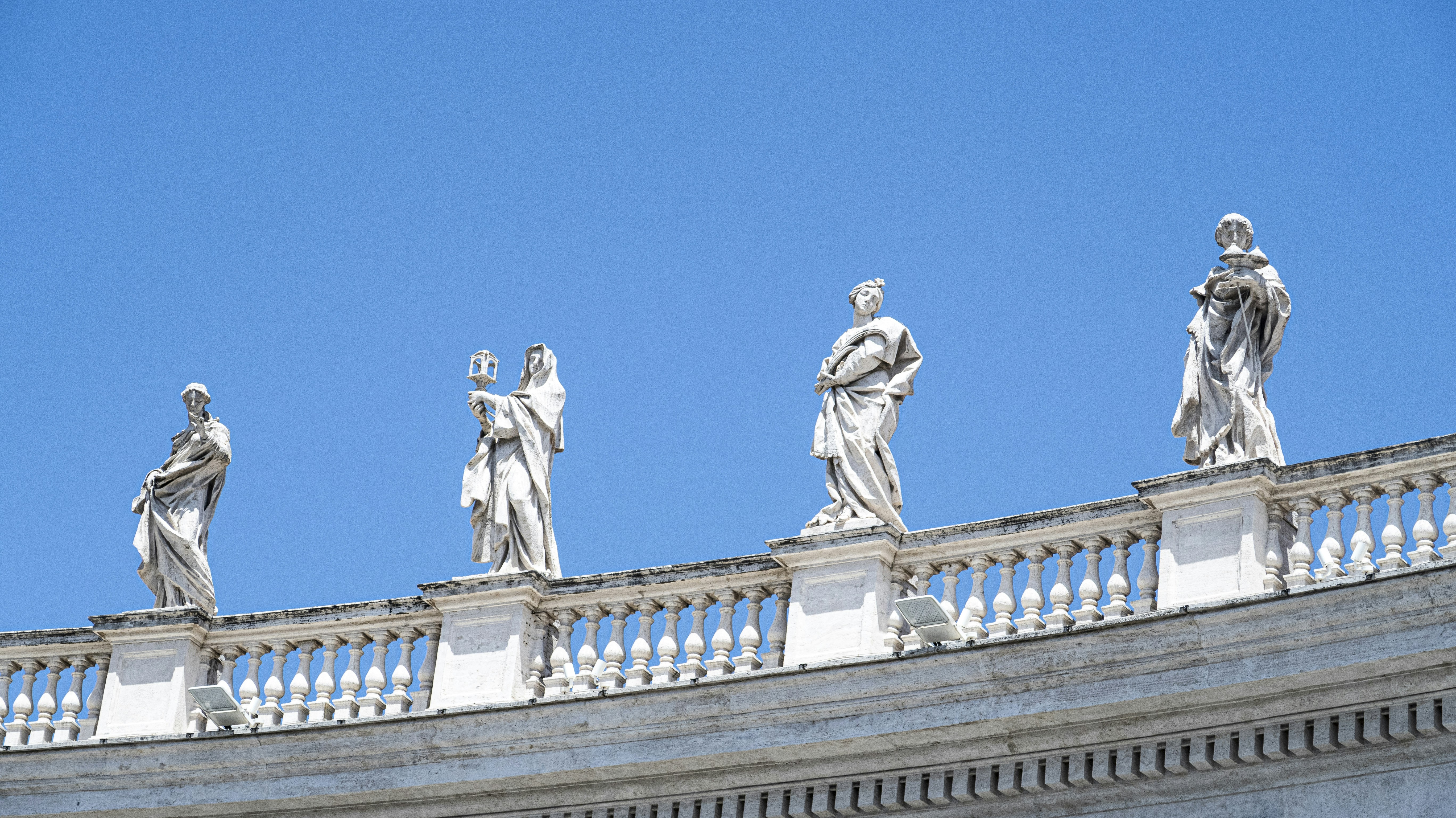 A group of statues on top of a building photo – Free Vatican city Image ...