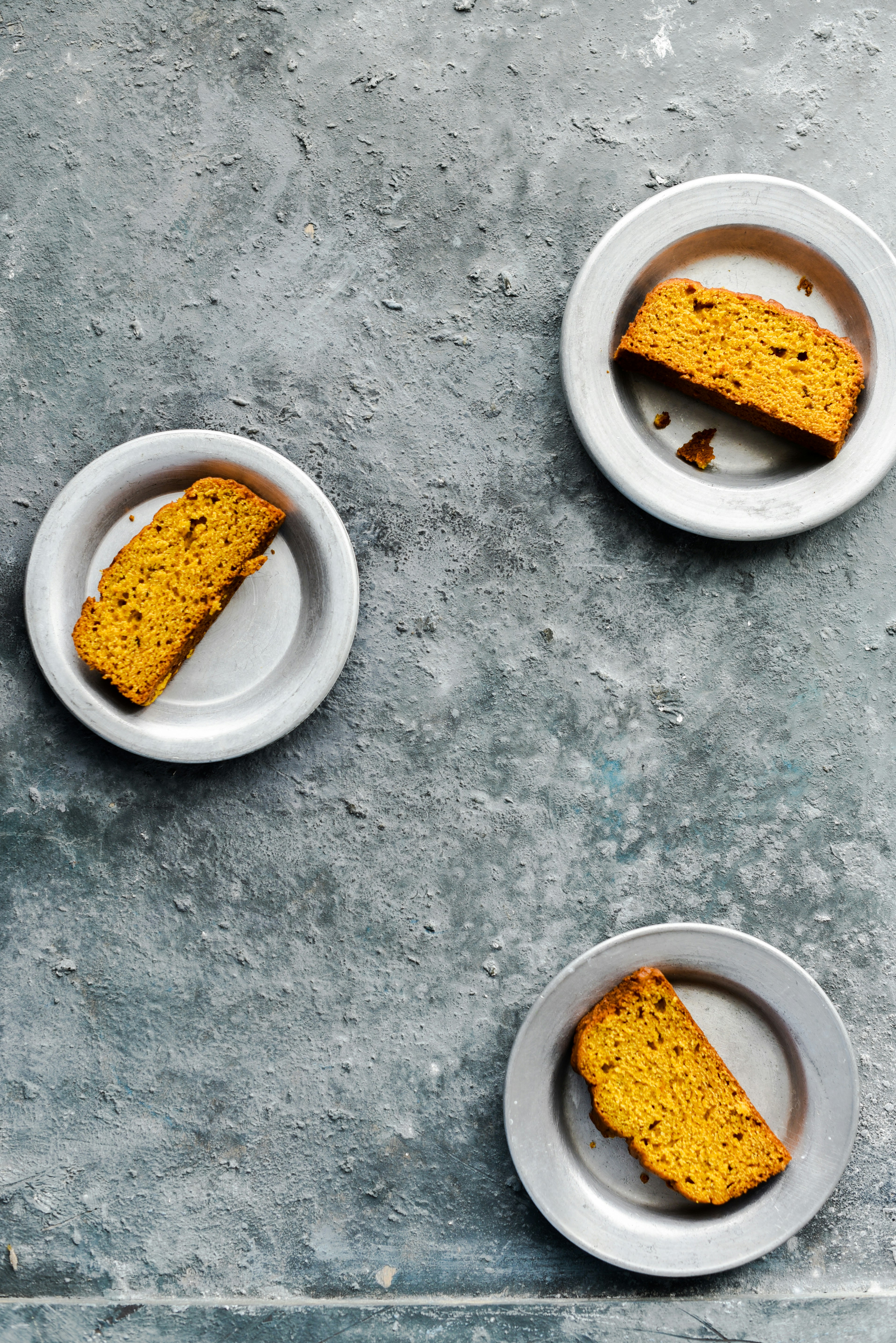 Minimalist Trio: Orange Cake Slices on a Concrete Canvas