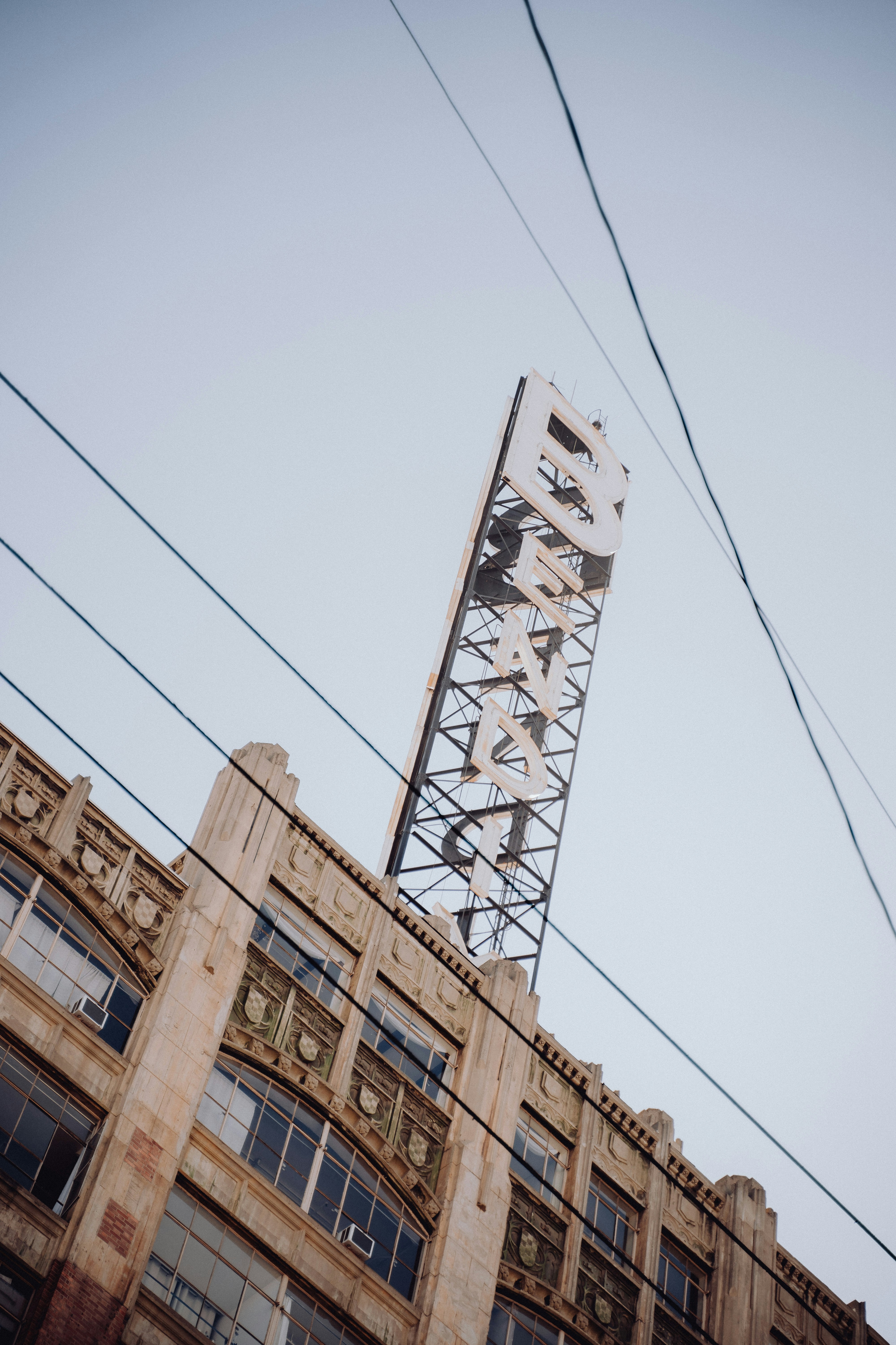 Tilted Letter Sign Rising Over a Vintage Brick Facade