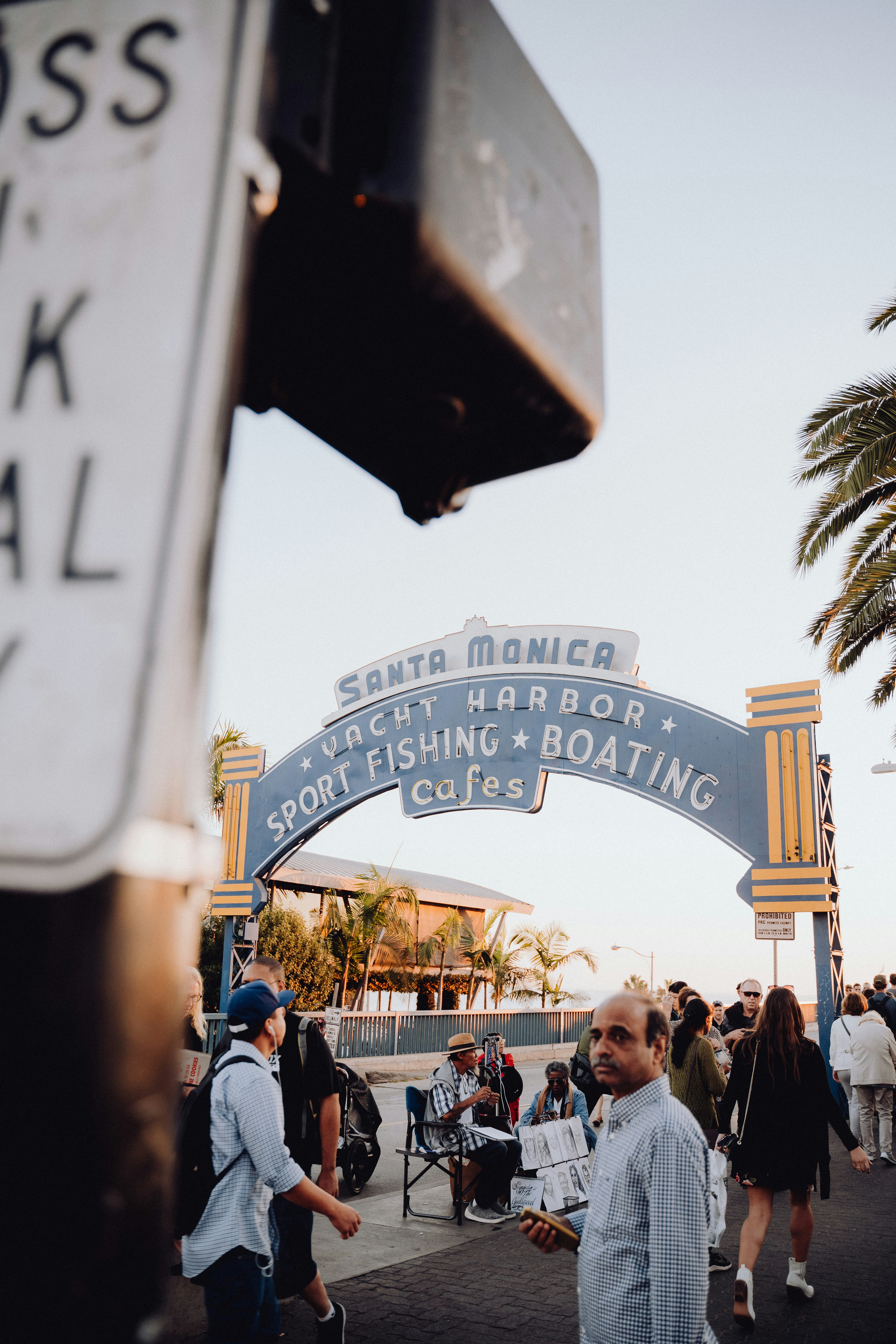 Beneath the Santa Monica Arch: People Gather at the Harbor Entrance