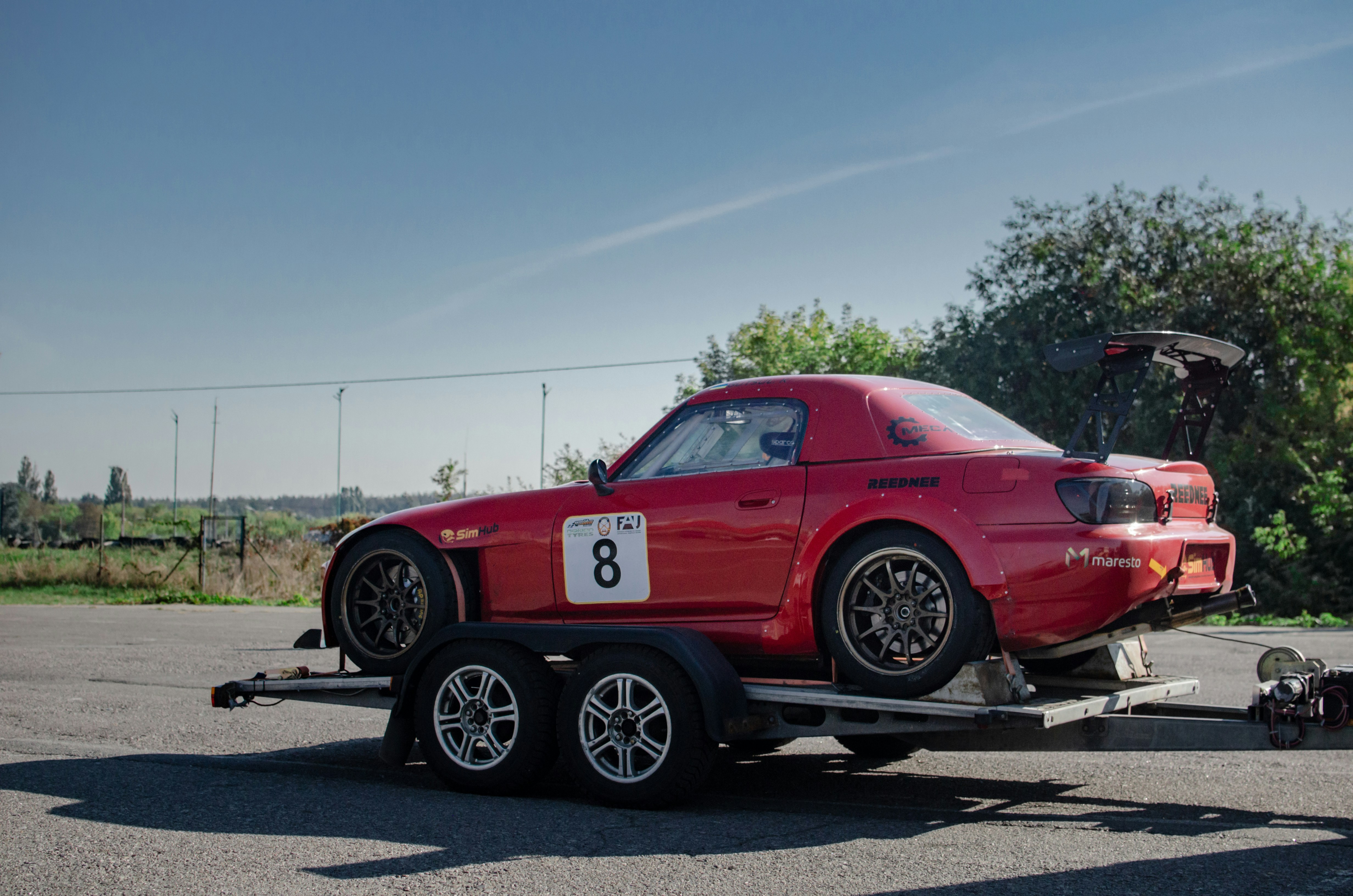 A red car being towed by a tow truck photo – Free Jdm Image on Unsplash
