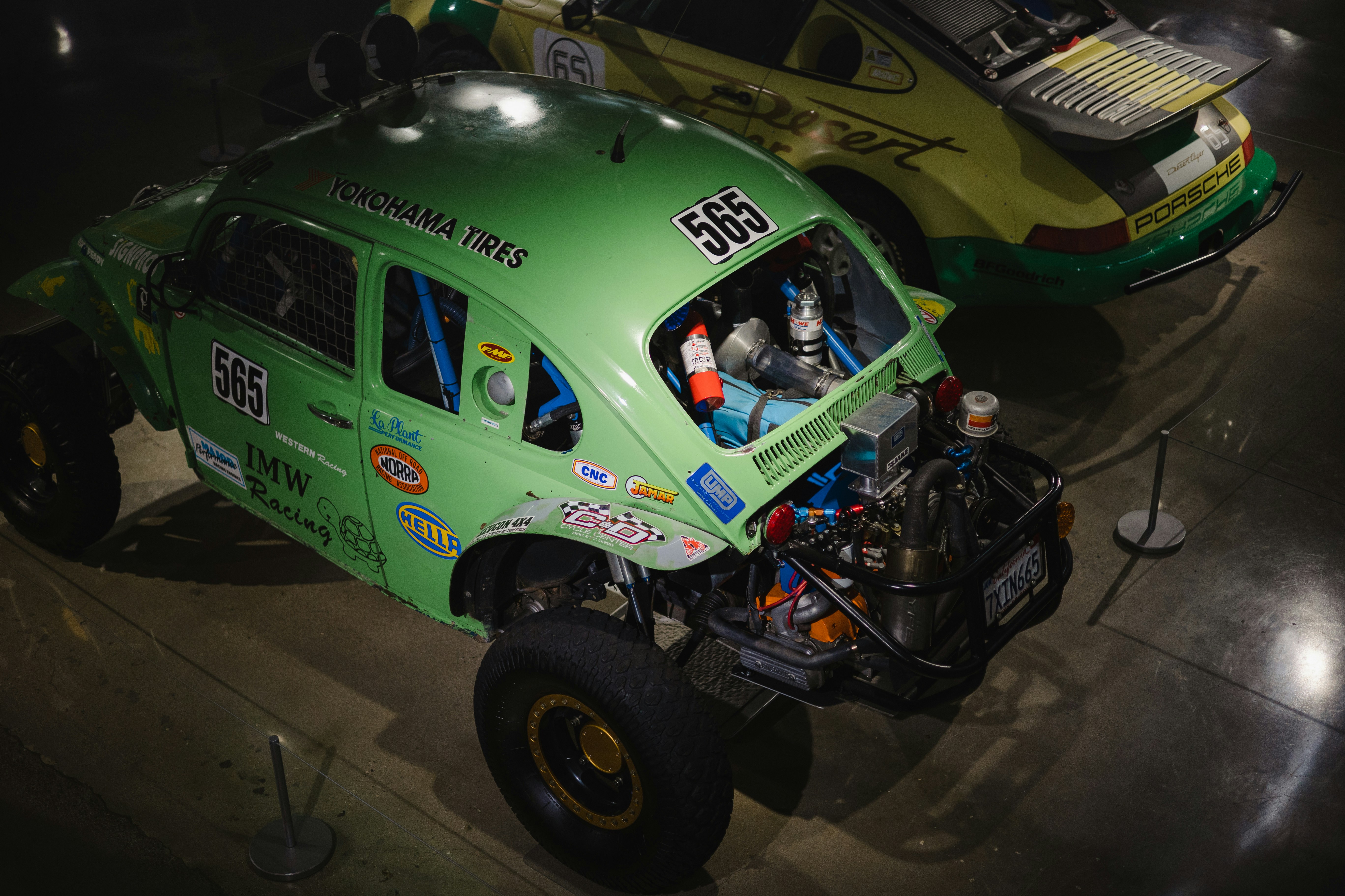 a green race car with a man in the driver's seat