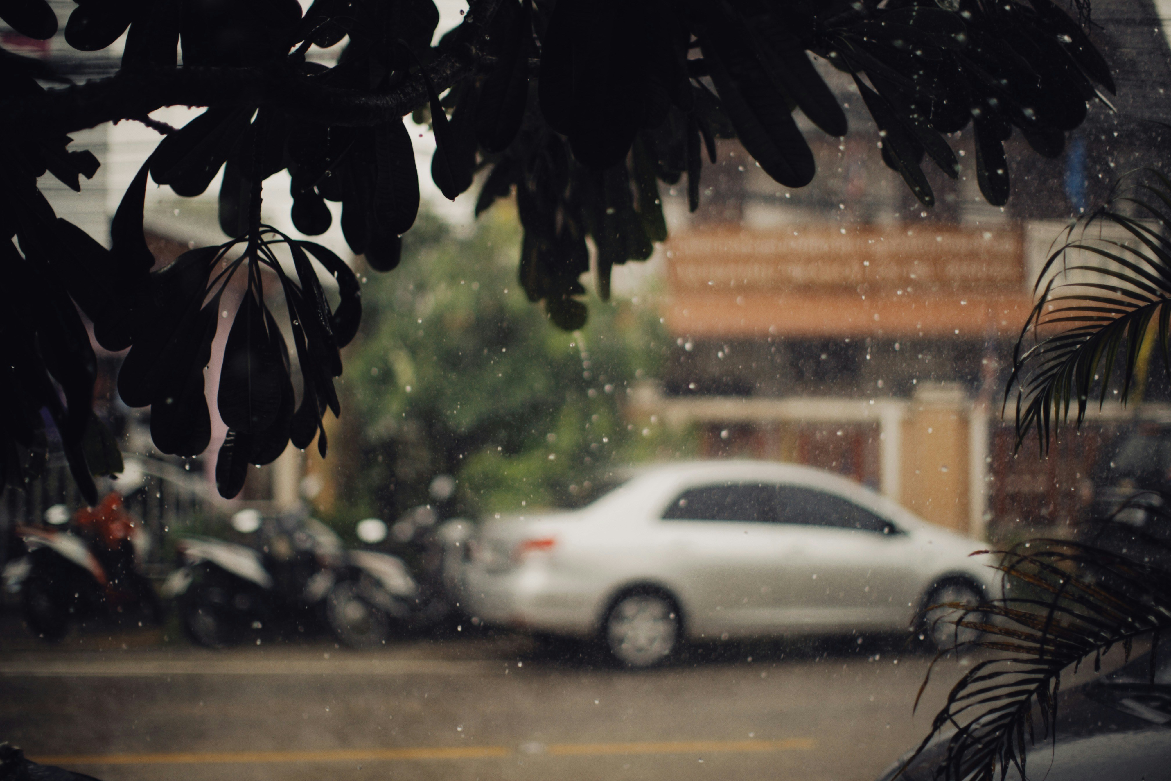 a white car parked on the side of a road