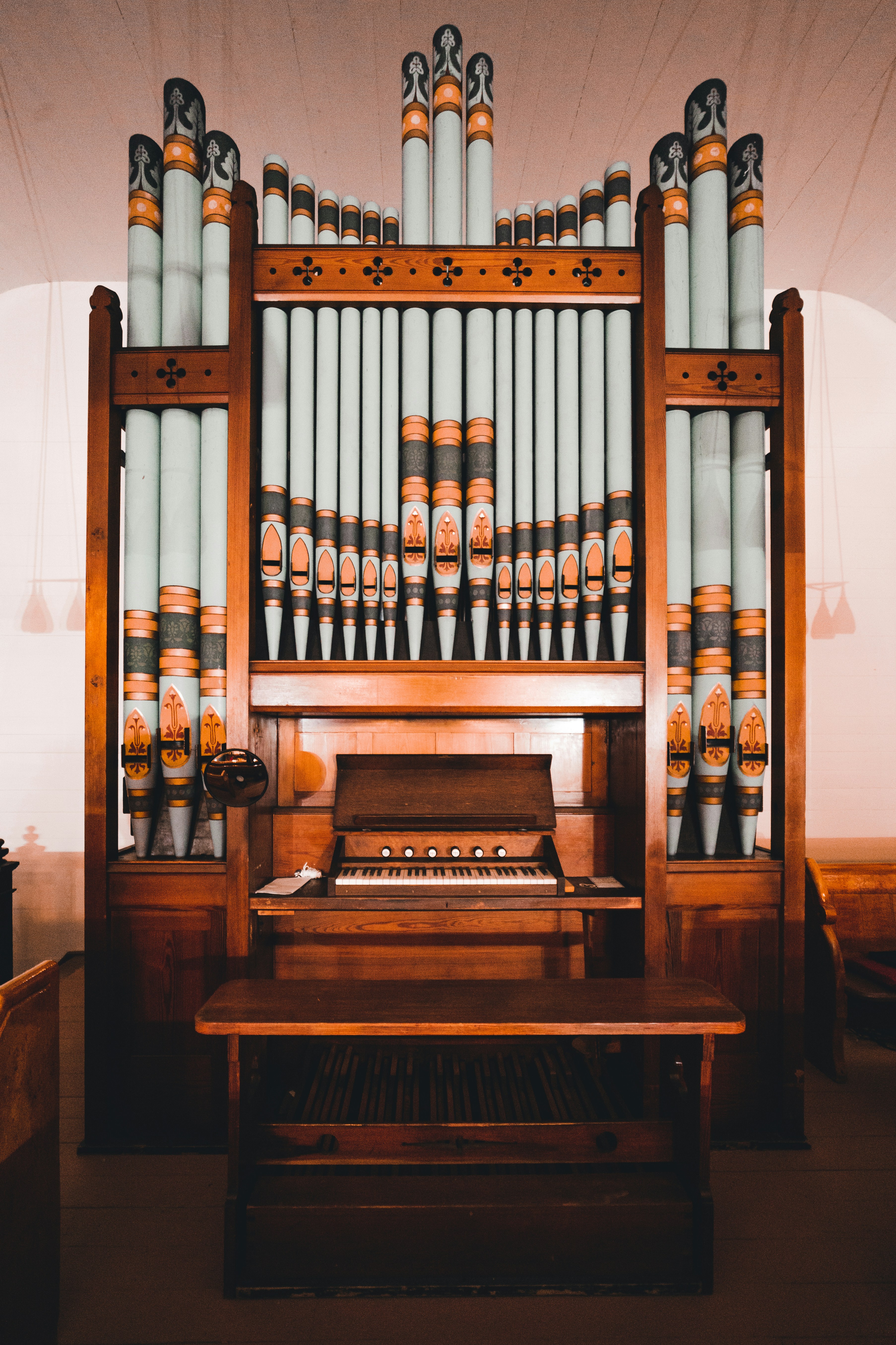 A pipe organ in a church with a bench in front of it photo – Free ...