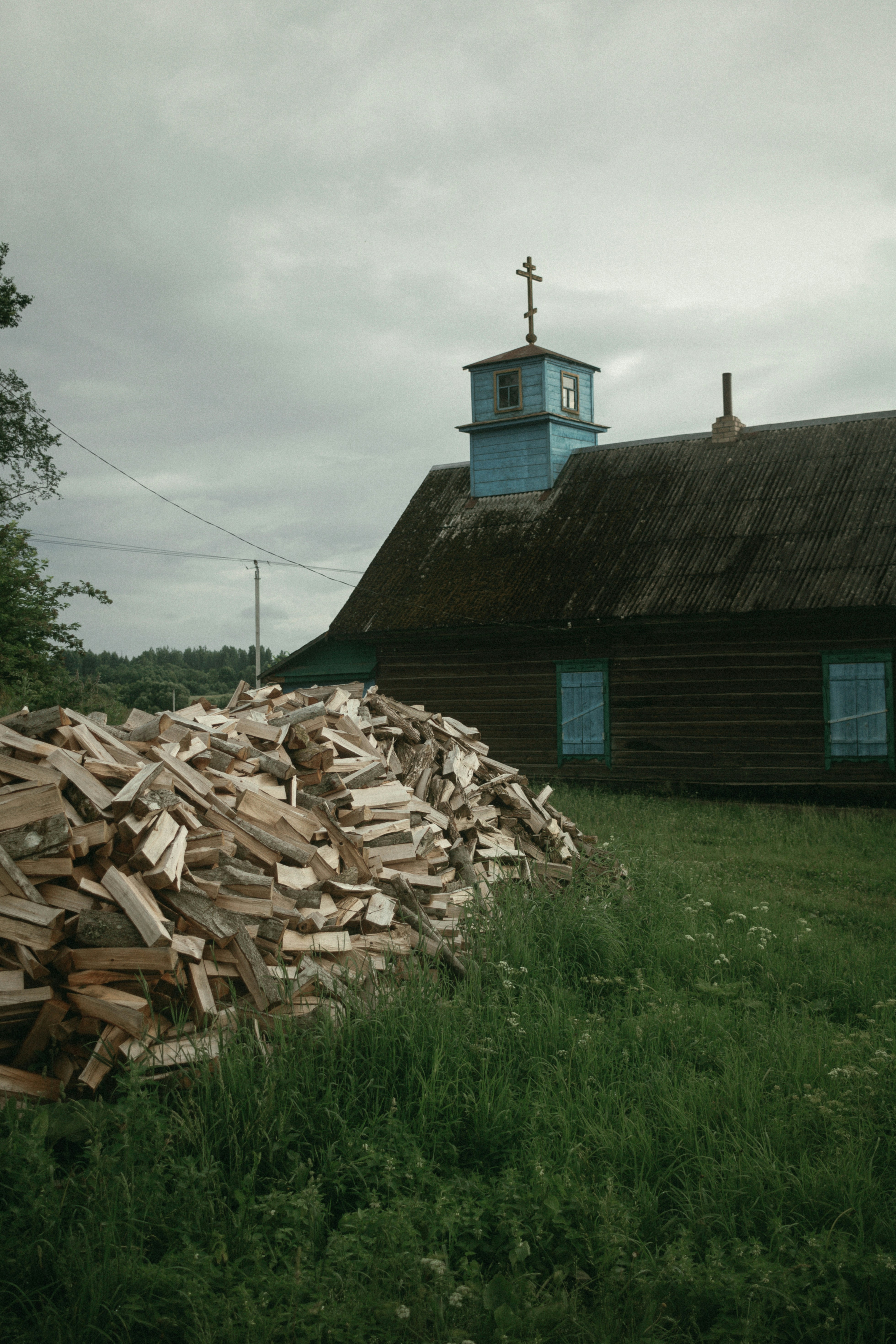 a pile of wood sitting in front of a building