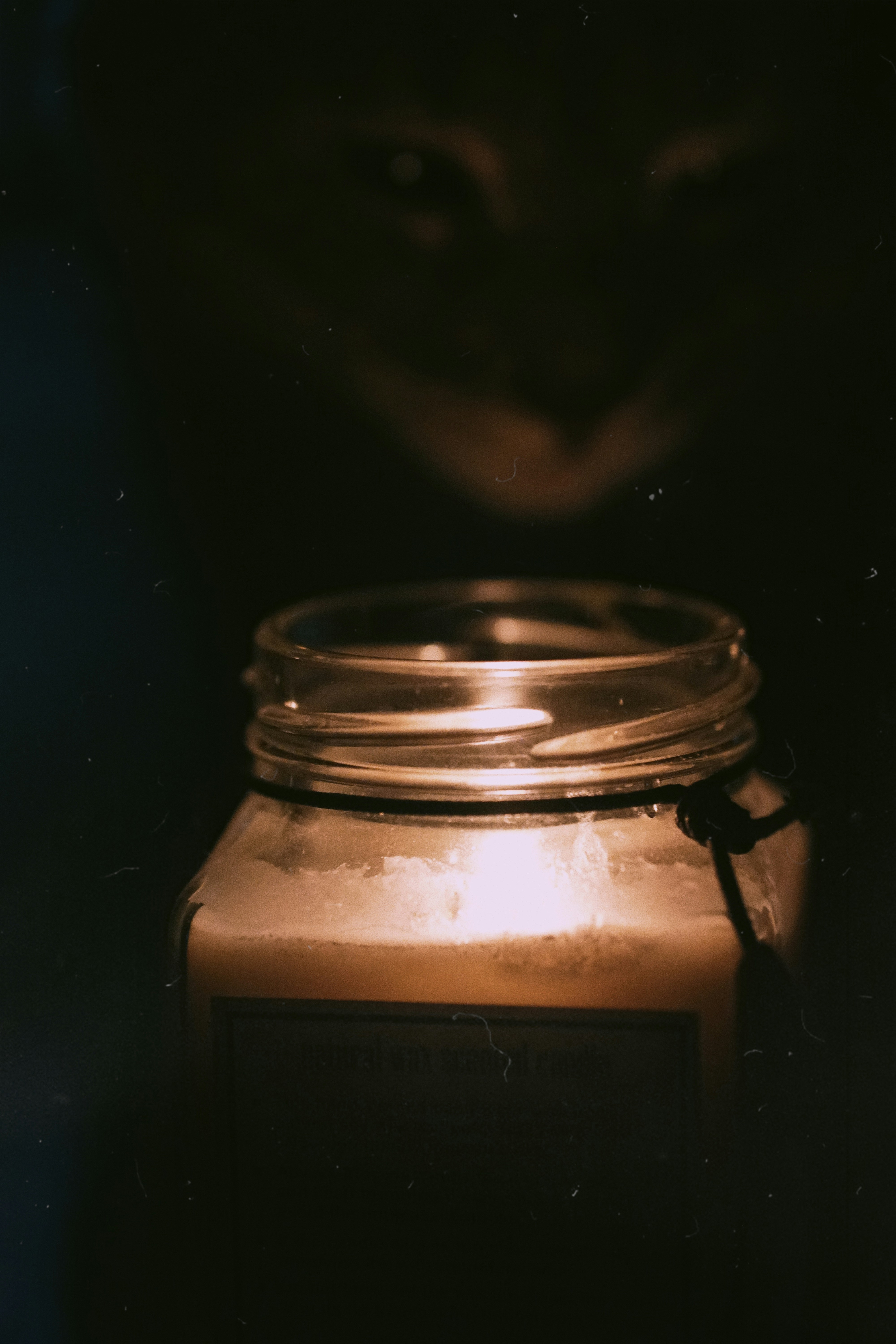 Lantern in the Dark: Warm Glow and a Shadowed Gaze