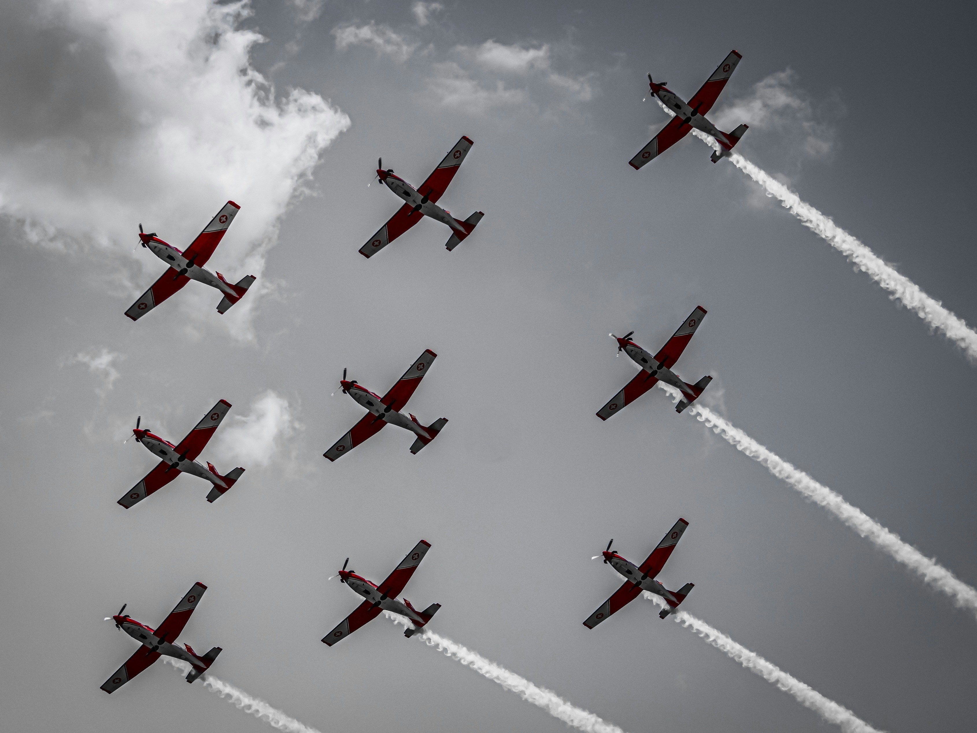 A group of planes flying through a cloudy sky photo – Free Zurich ...