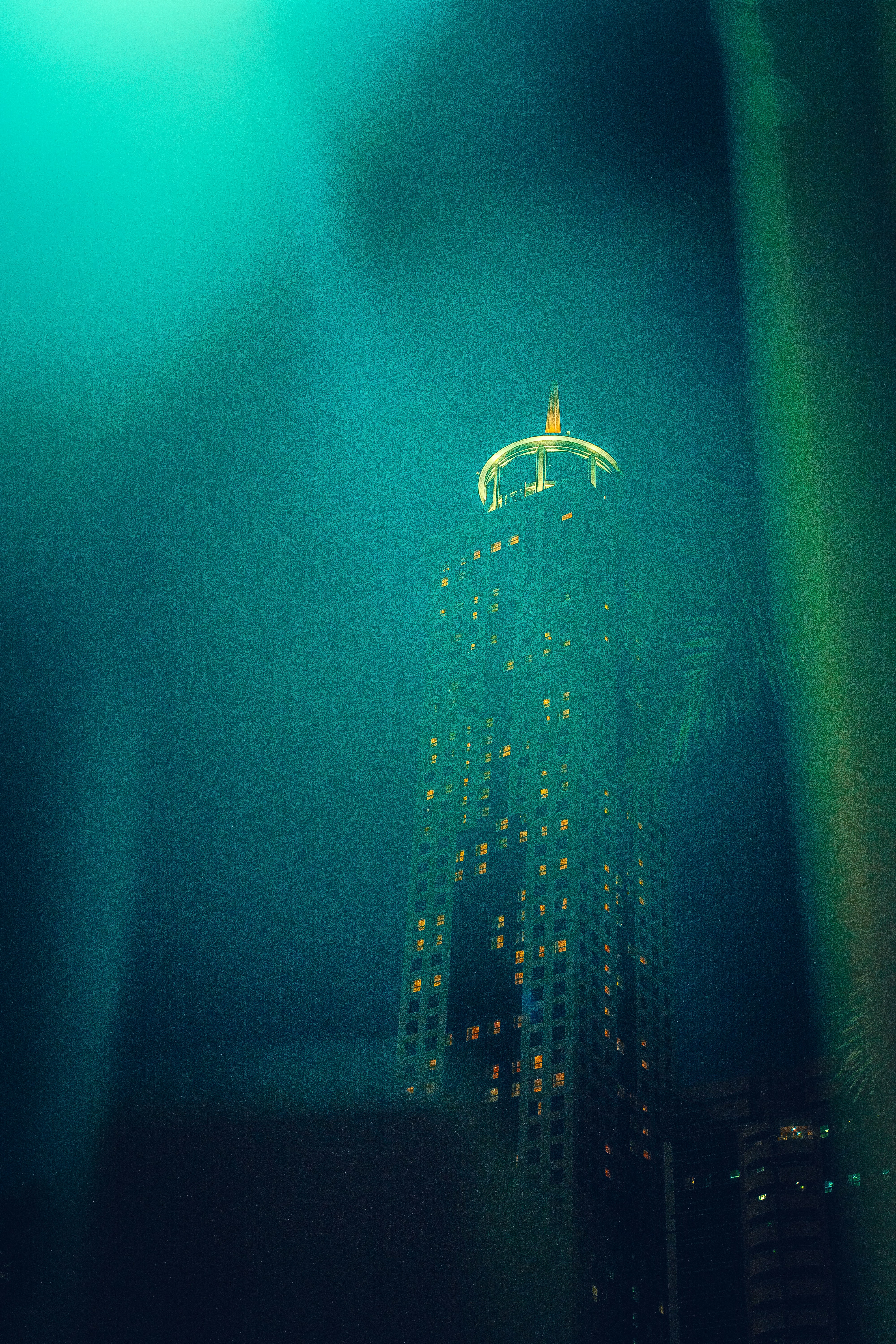 Crown of Lights: The Night Tower Rising Through Teal Haze