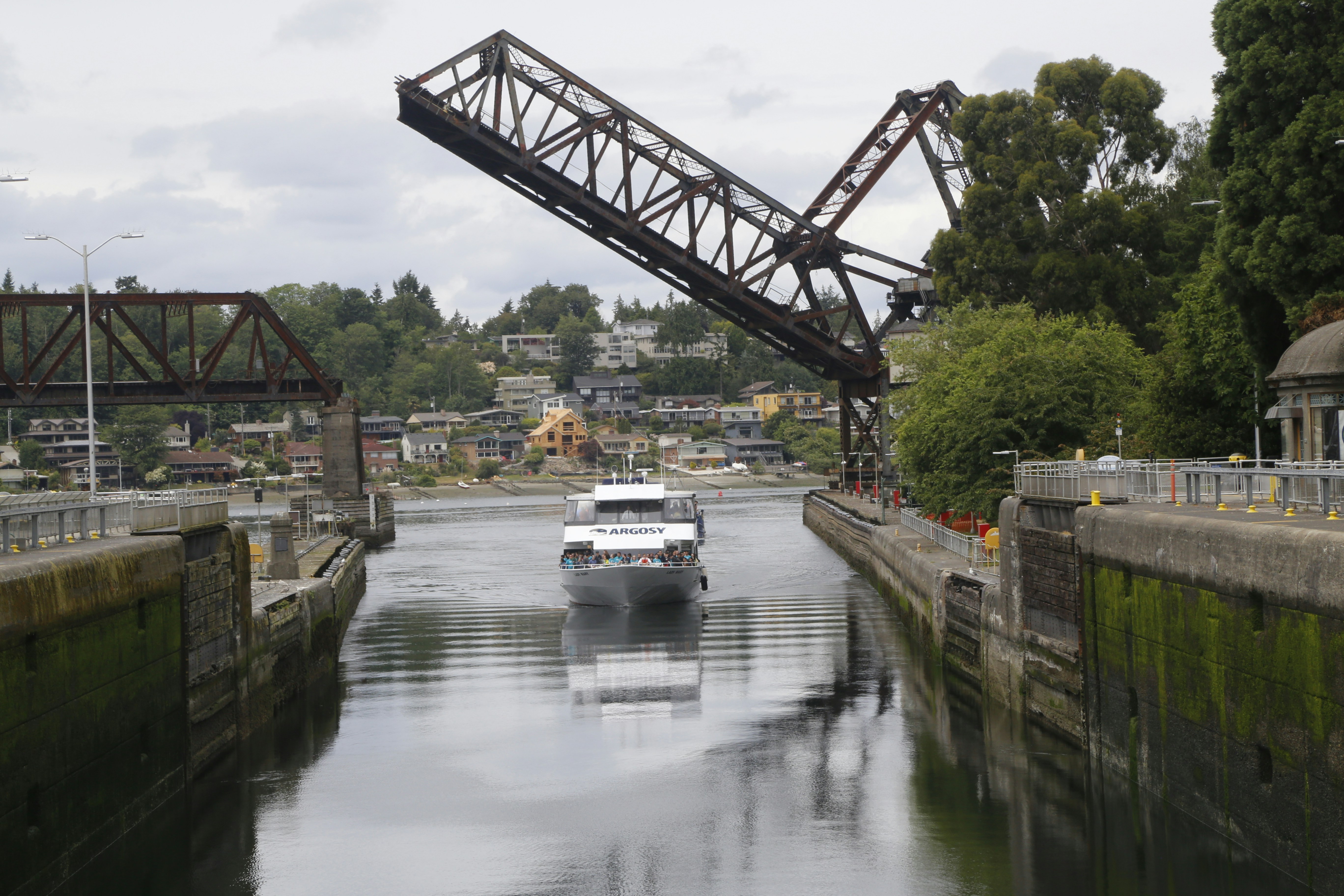 Narrowboat Under a Raised Canal Bridge: Tranquil Town Backdrop