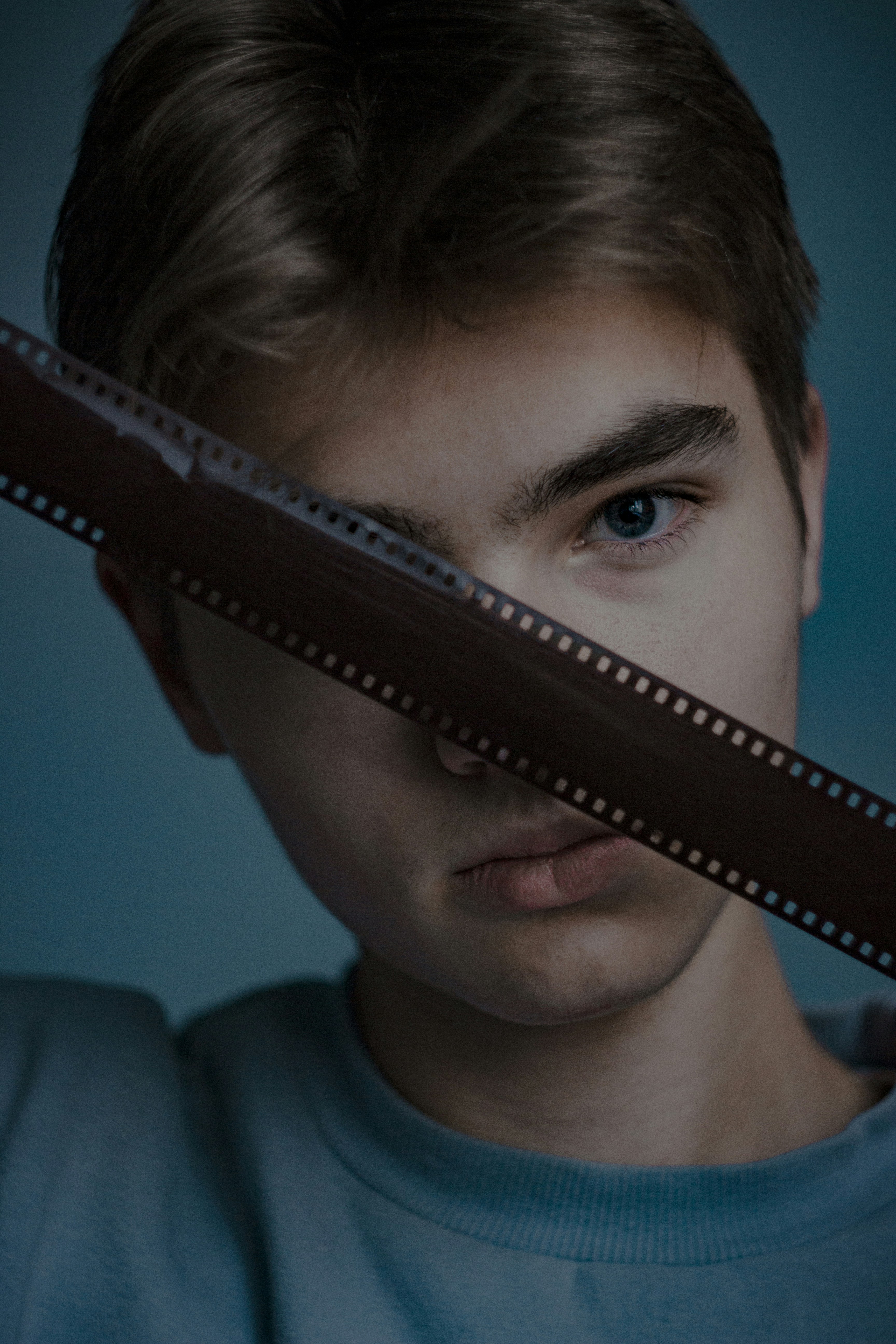 Split gaze: a film strip cuts through a moody portrait