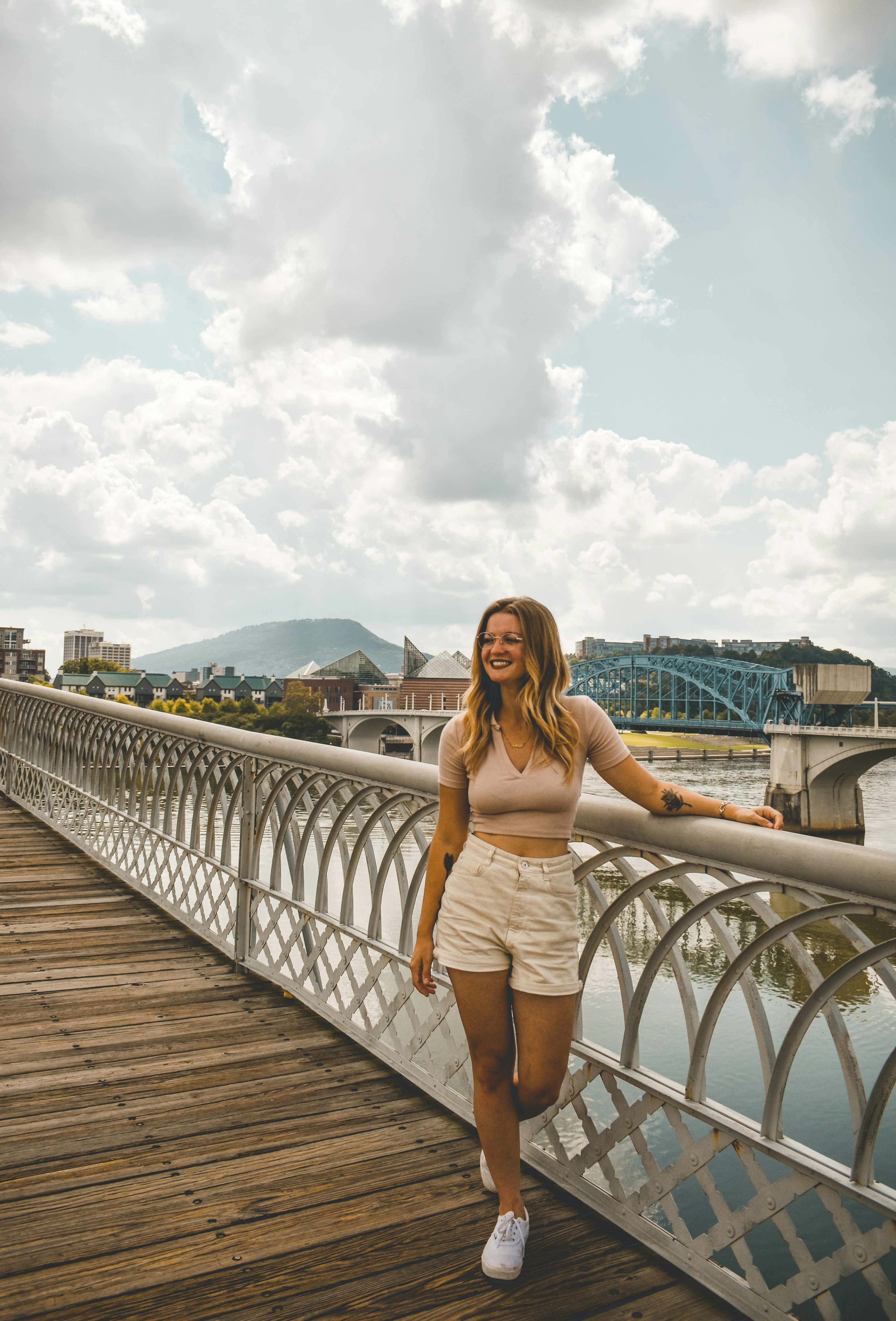 Sunlit Riverside Portrait on a Curved-rail Boardwalk