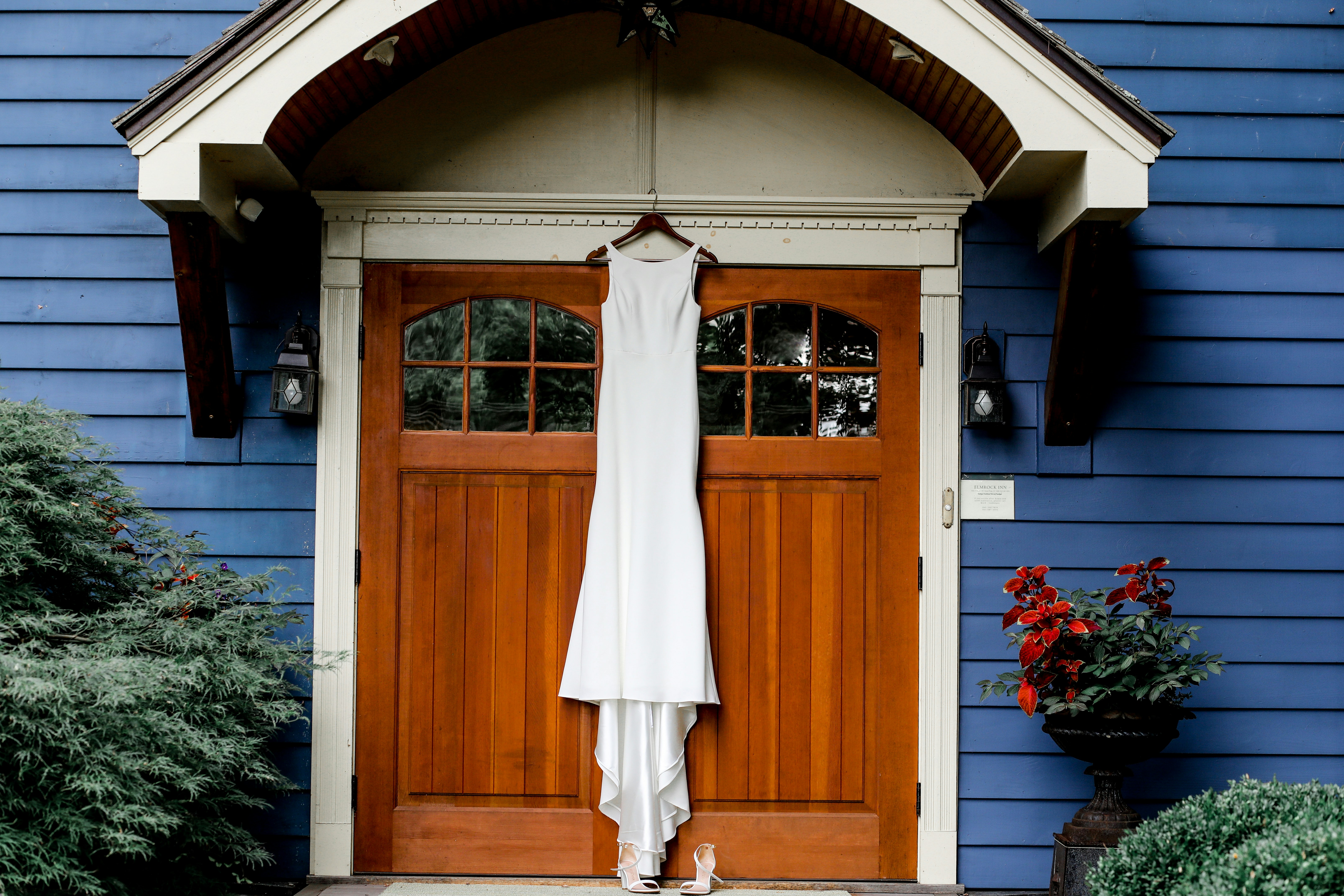 White Dress on a Blue Doorway: A Quiet Garment at the Threshold