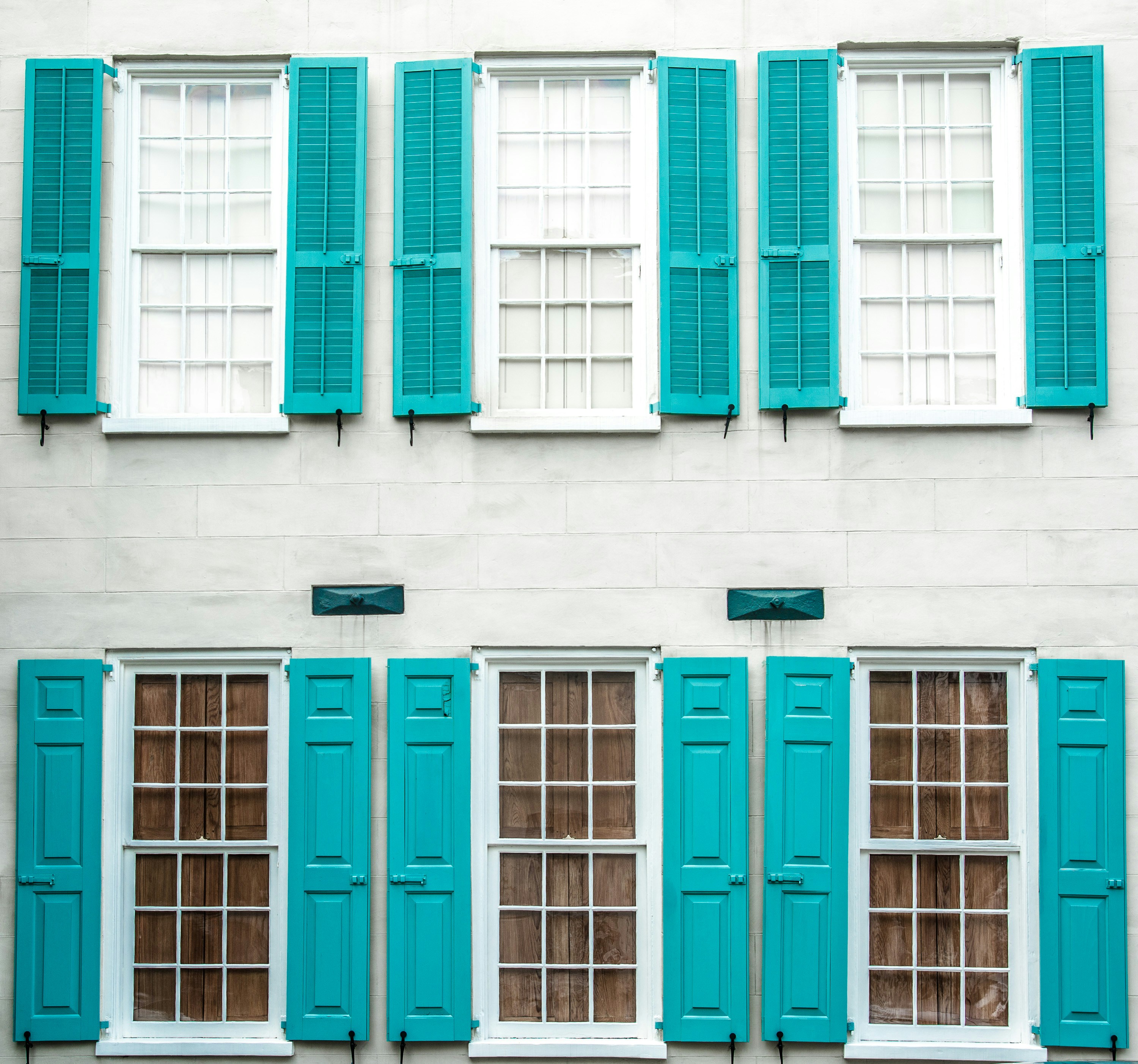 A white building with blue shutters and windows photo – Free Windows ...