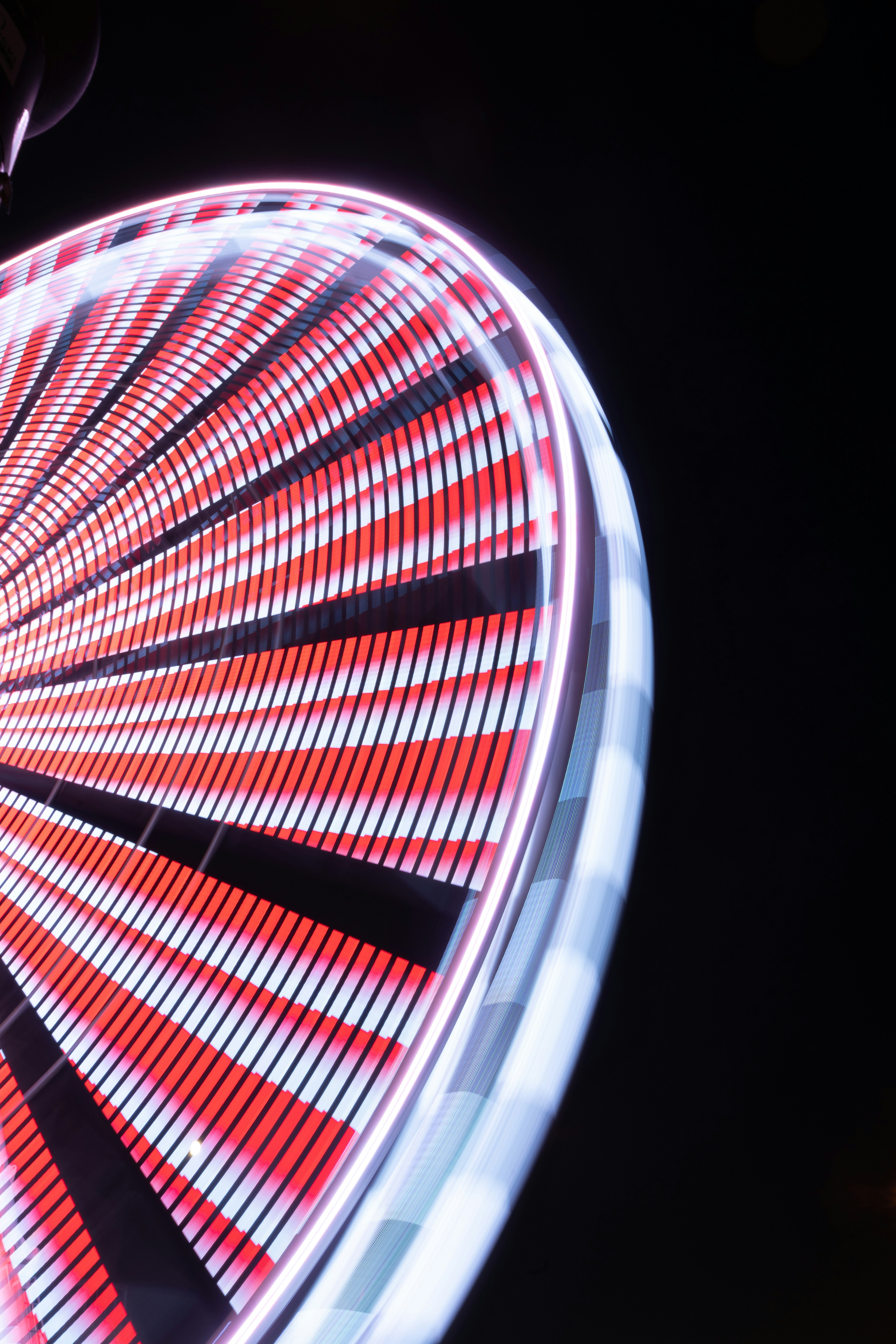 Crimson Arc: A Long-Exposure Spin of a Night Ferris Wheel