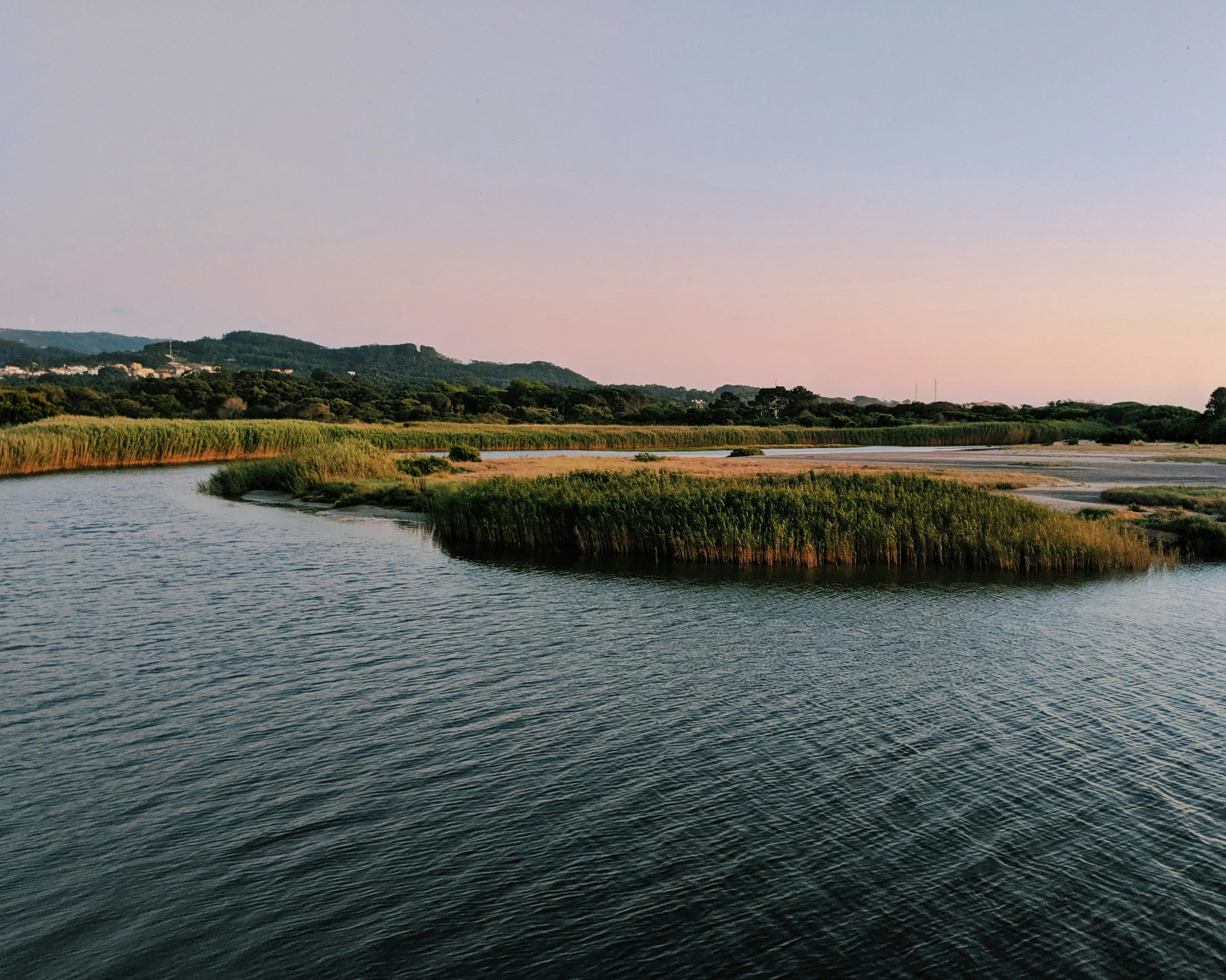 a body of water with a small island in the middle of it