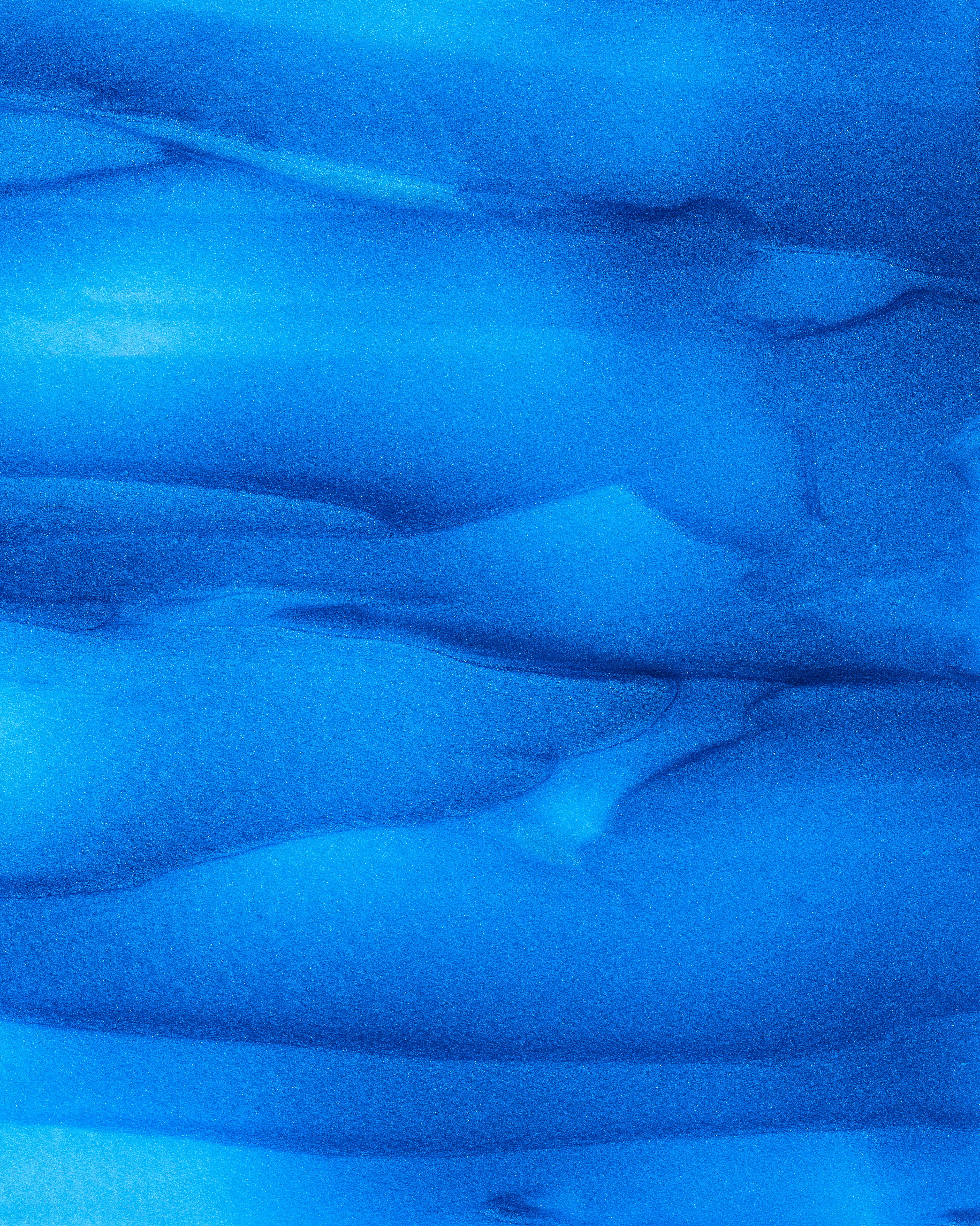 A close up of a blue substance in the water photo – Free Blue Image on ...