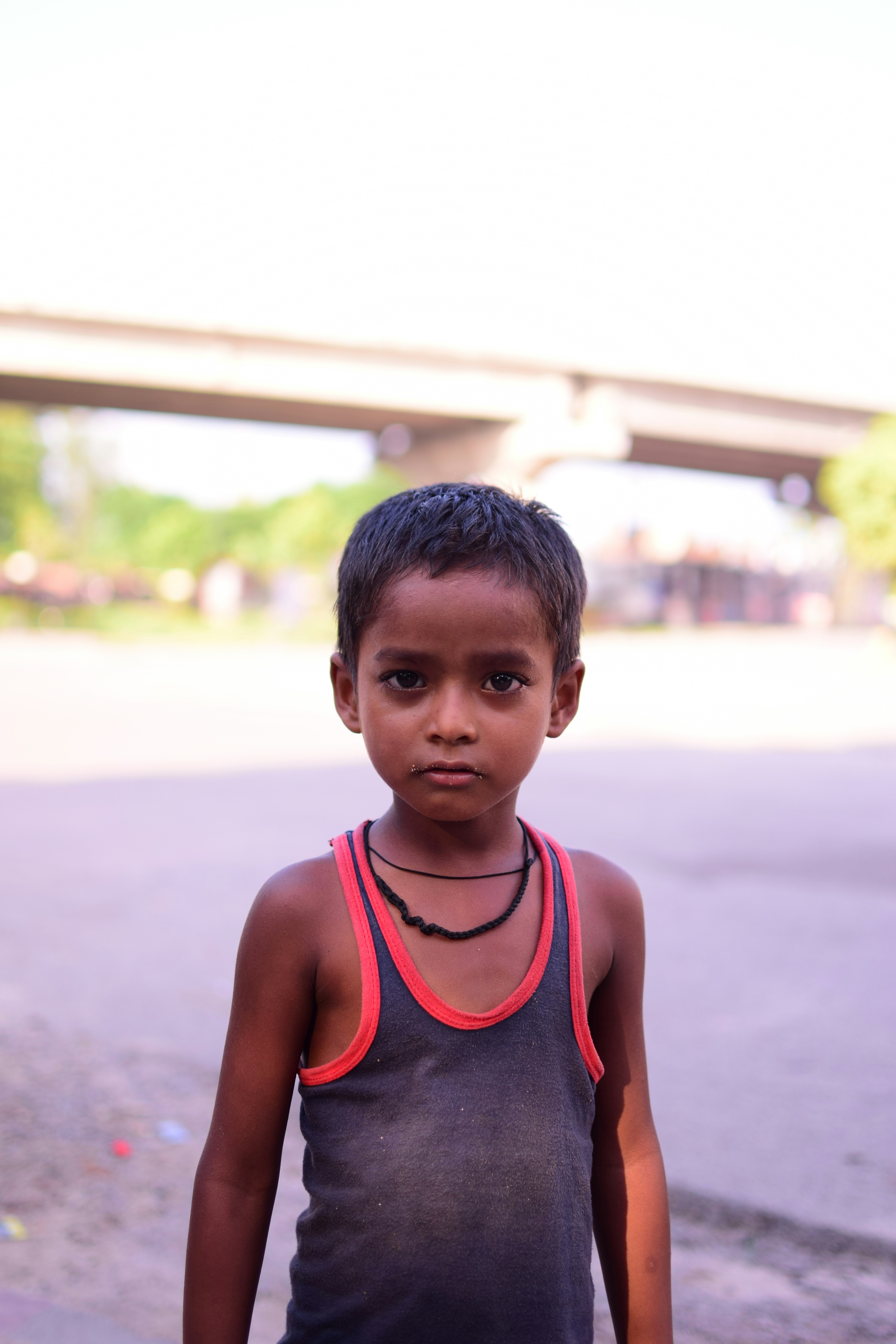 A young boy standing on the side of a road photo – Free Human Image on ...