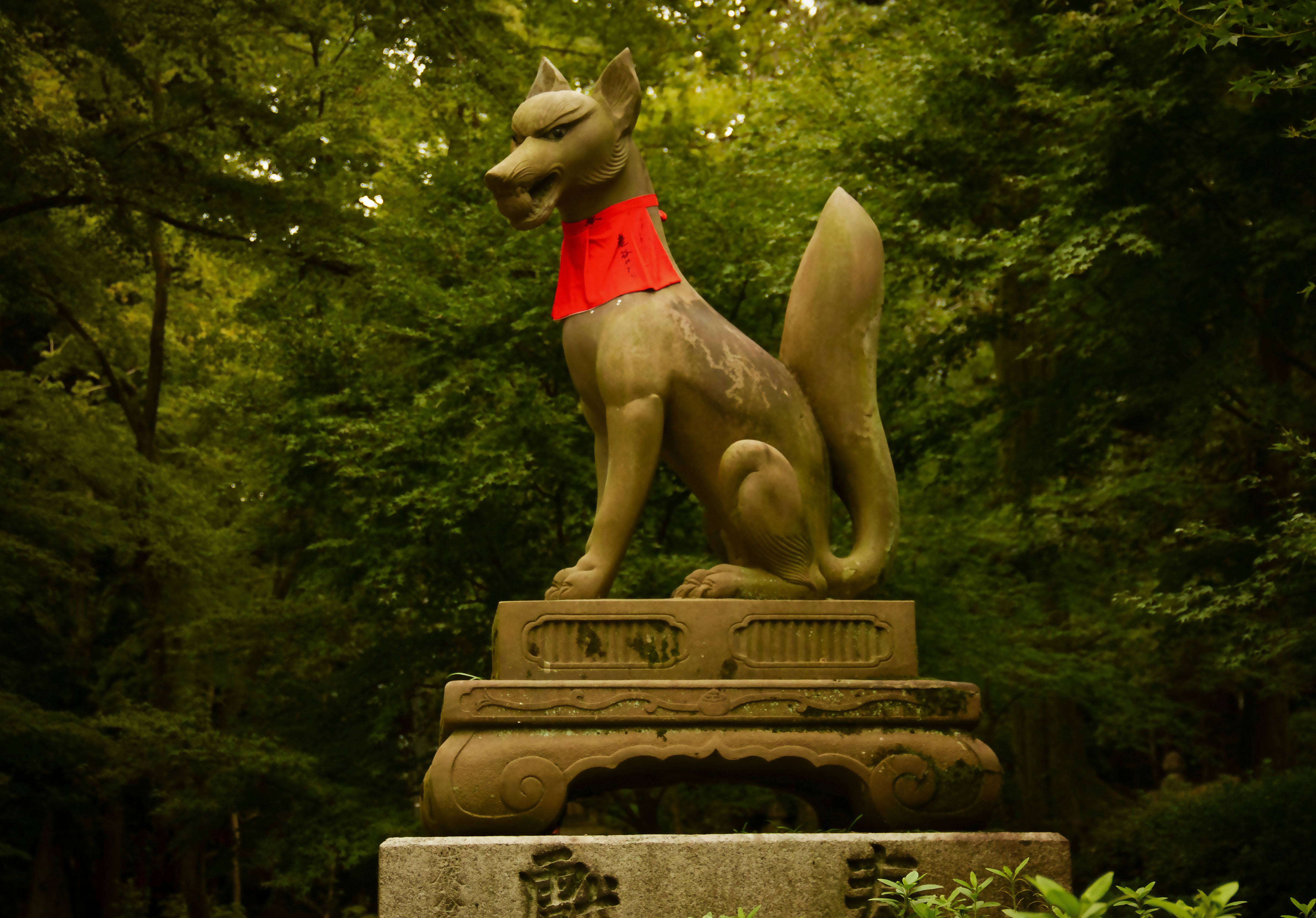 a statue of a dog with a red collar
