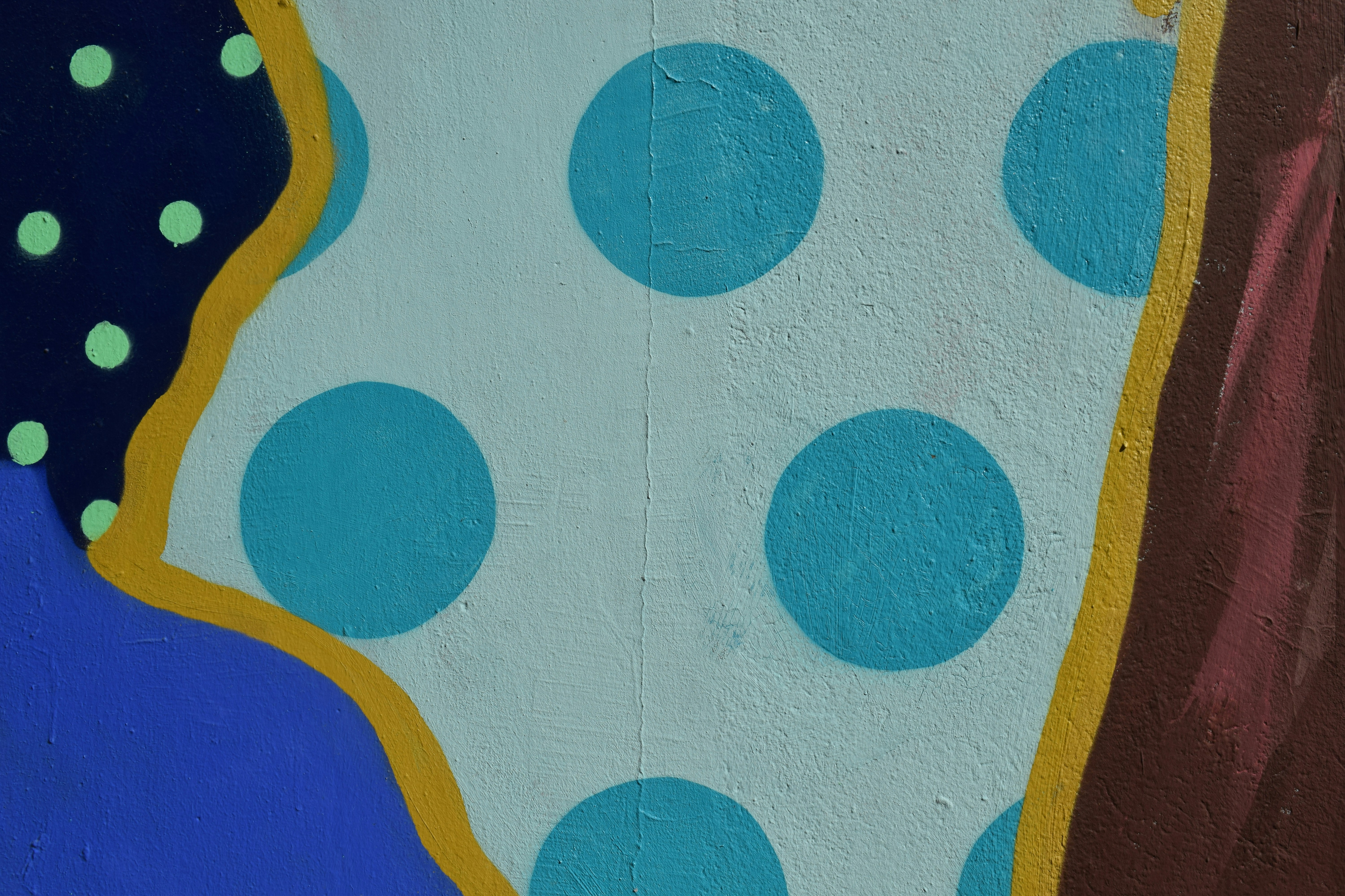 Blue Polka Graffiti Under Sunlit Arch