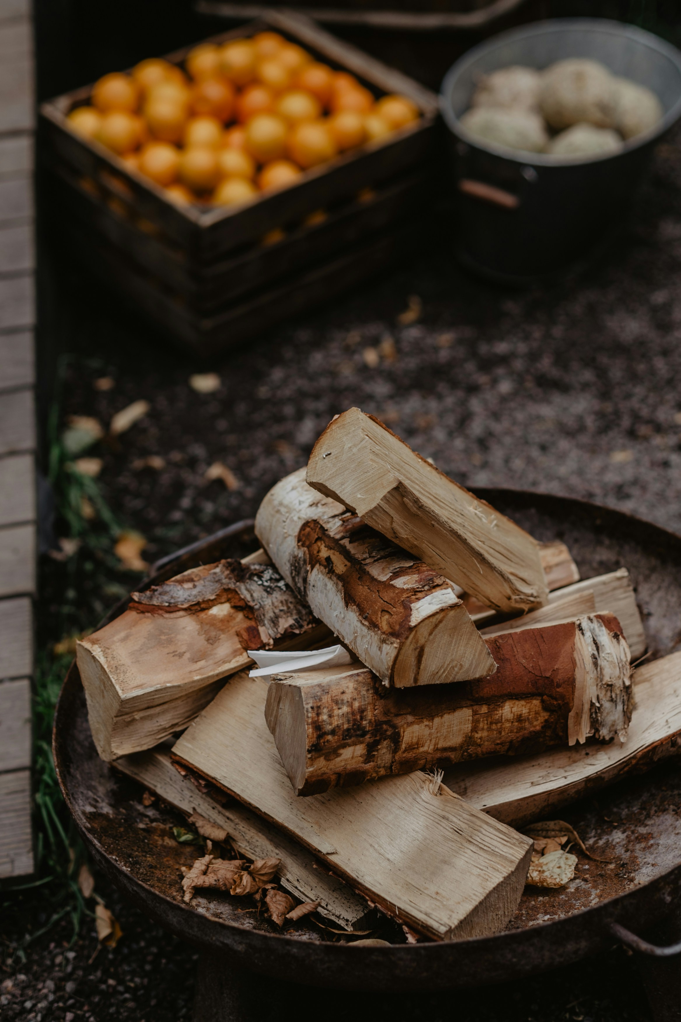 Warm Split: Firewood Stack Framed by Outdoor Kitchen Ambiance