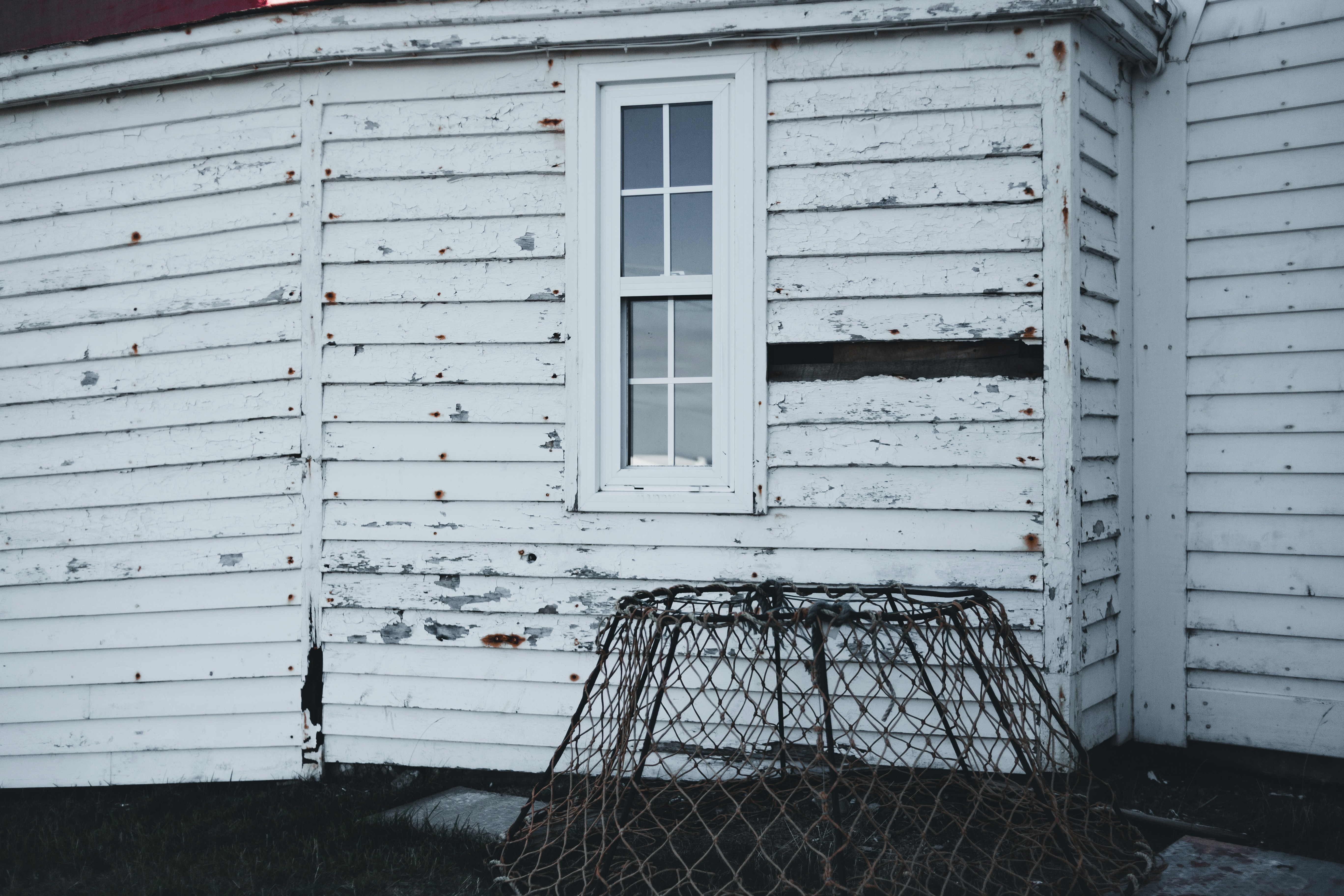 Weathered White Wall and Wire Dome: A Quiet Decay