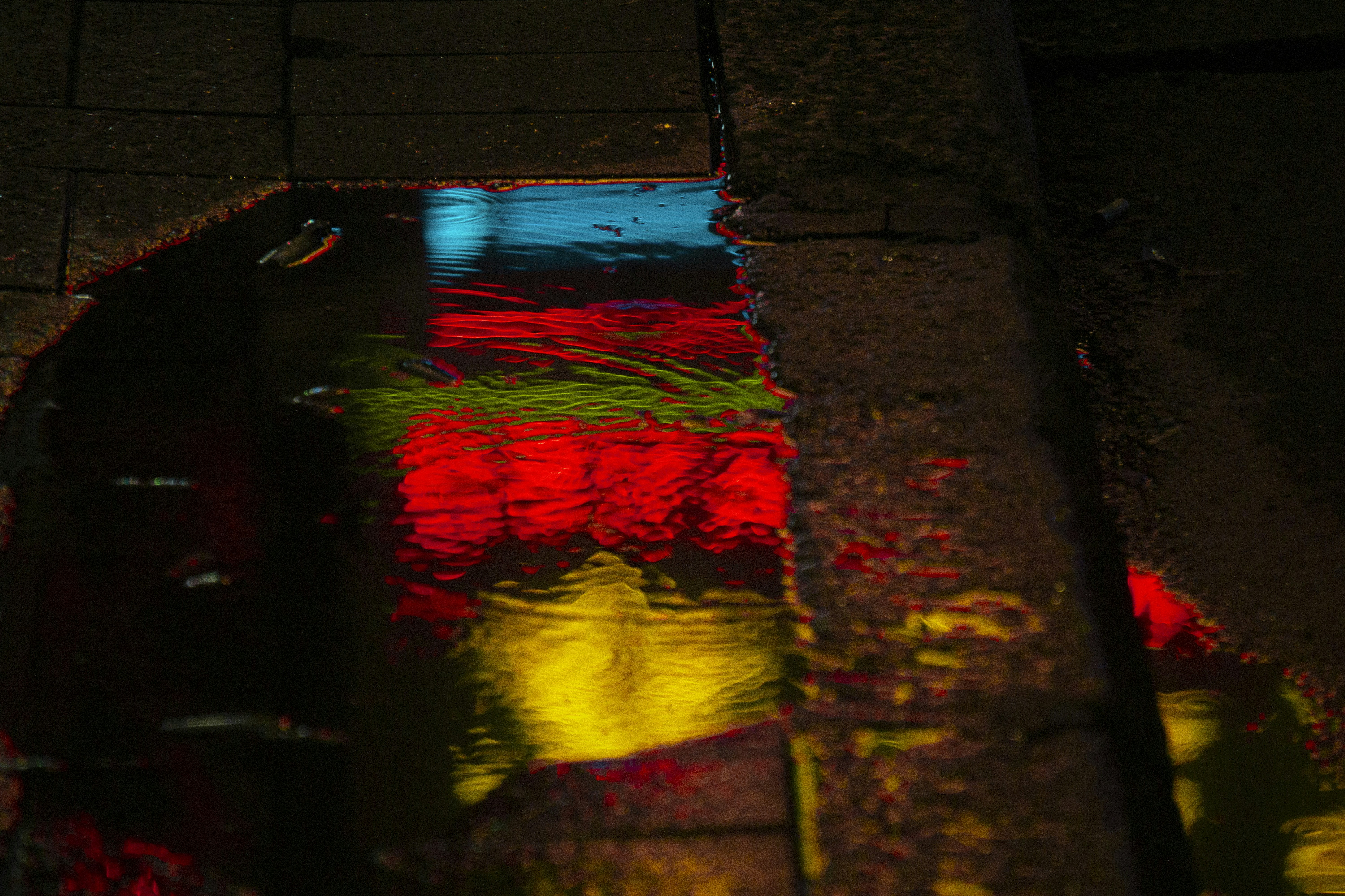 A reflection of a stop sign in a puddle of water photo – Free Art Image ...
