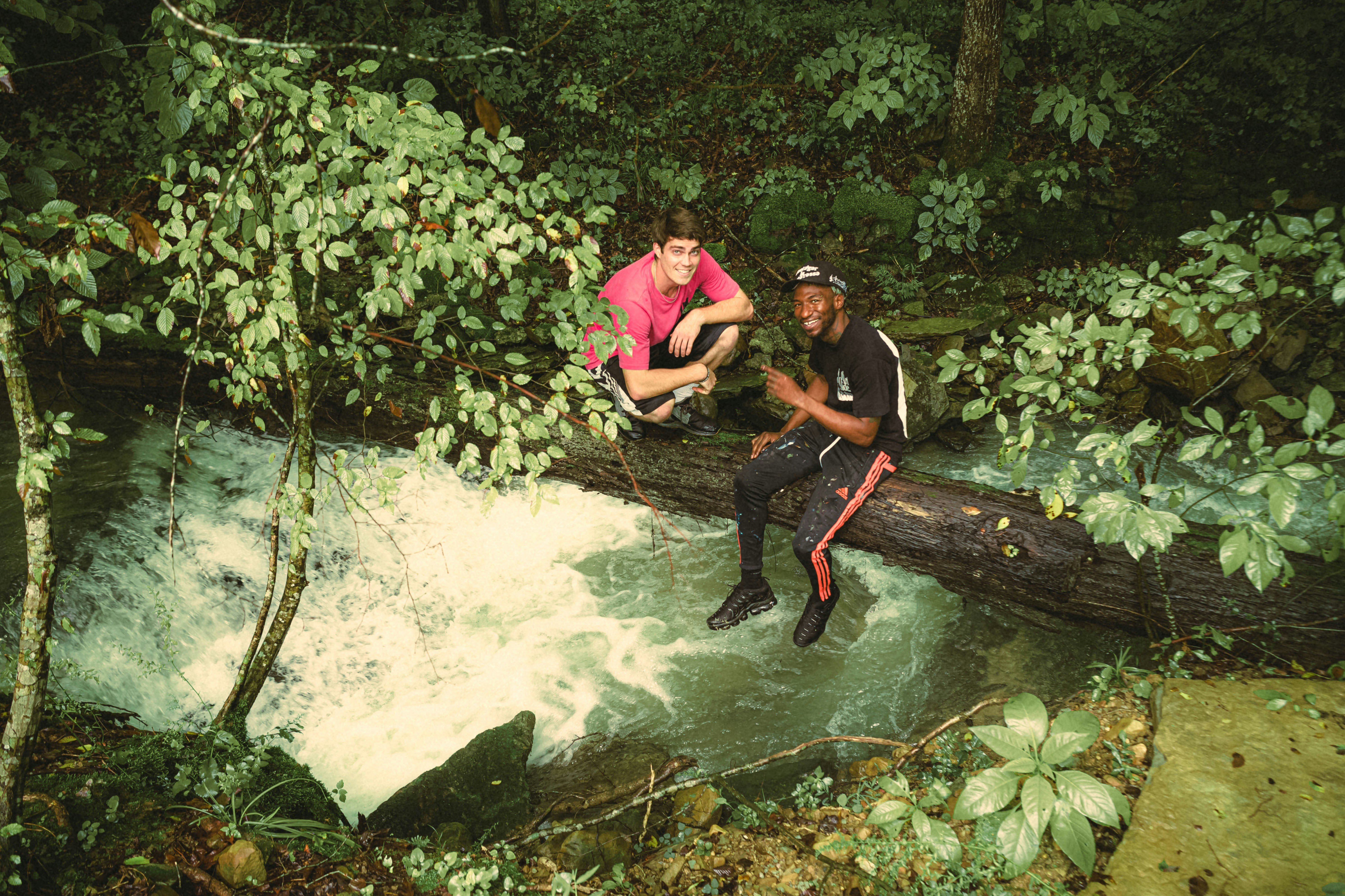 Two people sitting on a log over a river photo – Free Apparel Image on ...