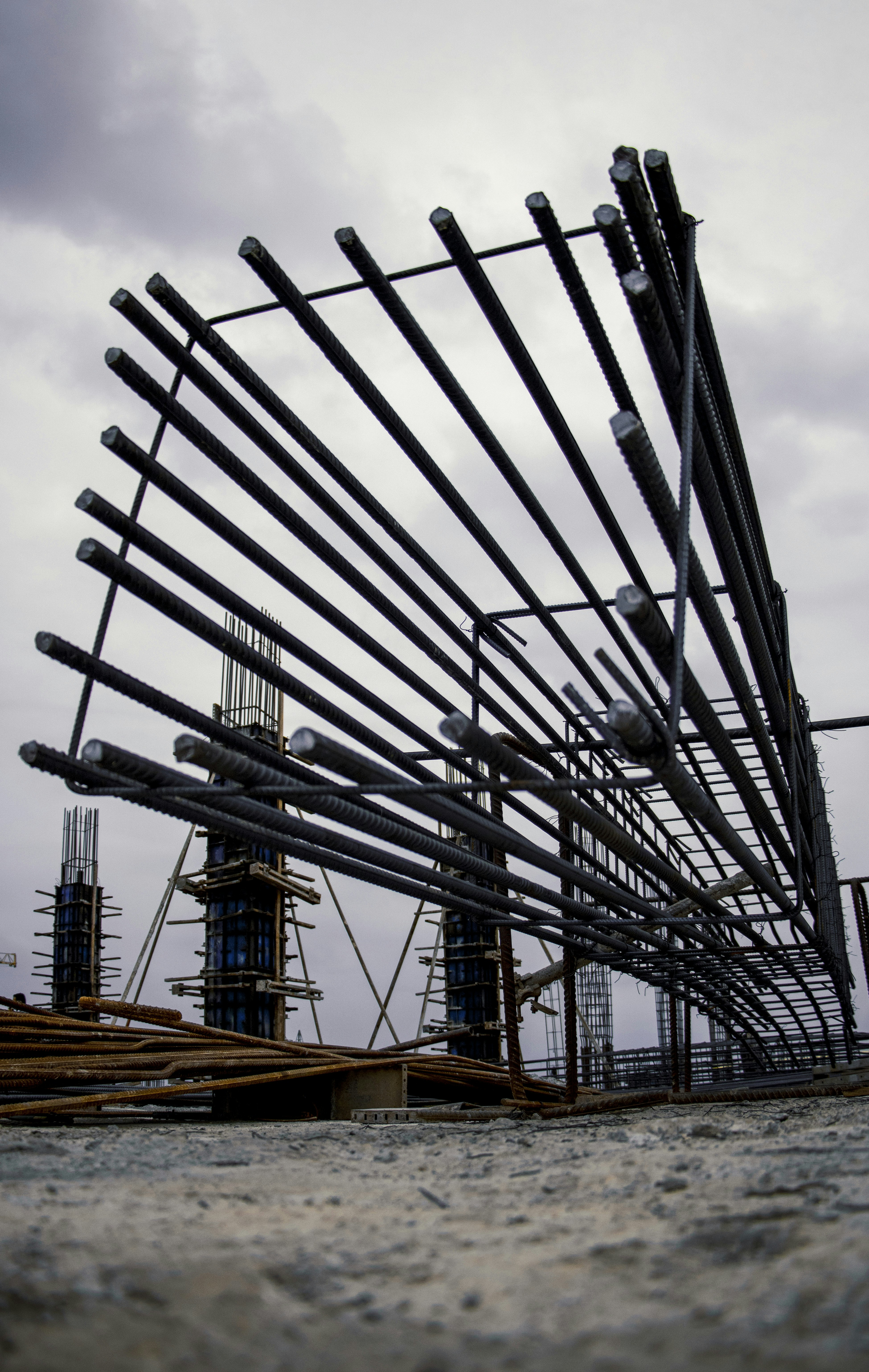Fan of Steel: The Radial Rebar Cage Piercing a Concrete Skeleton