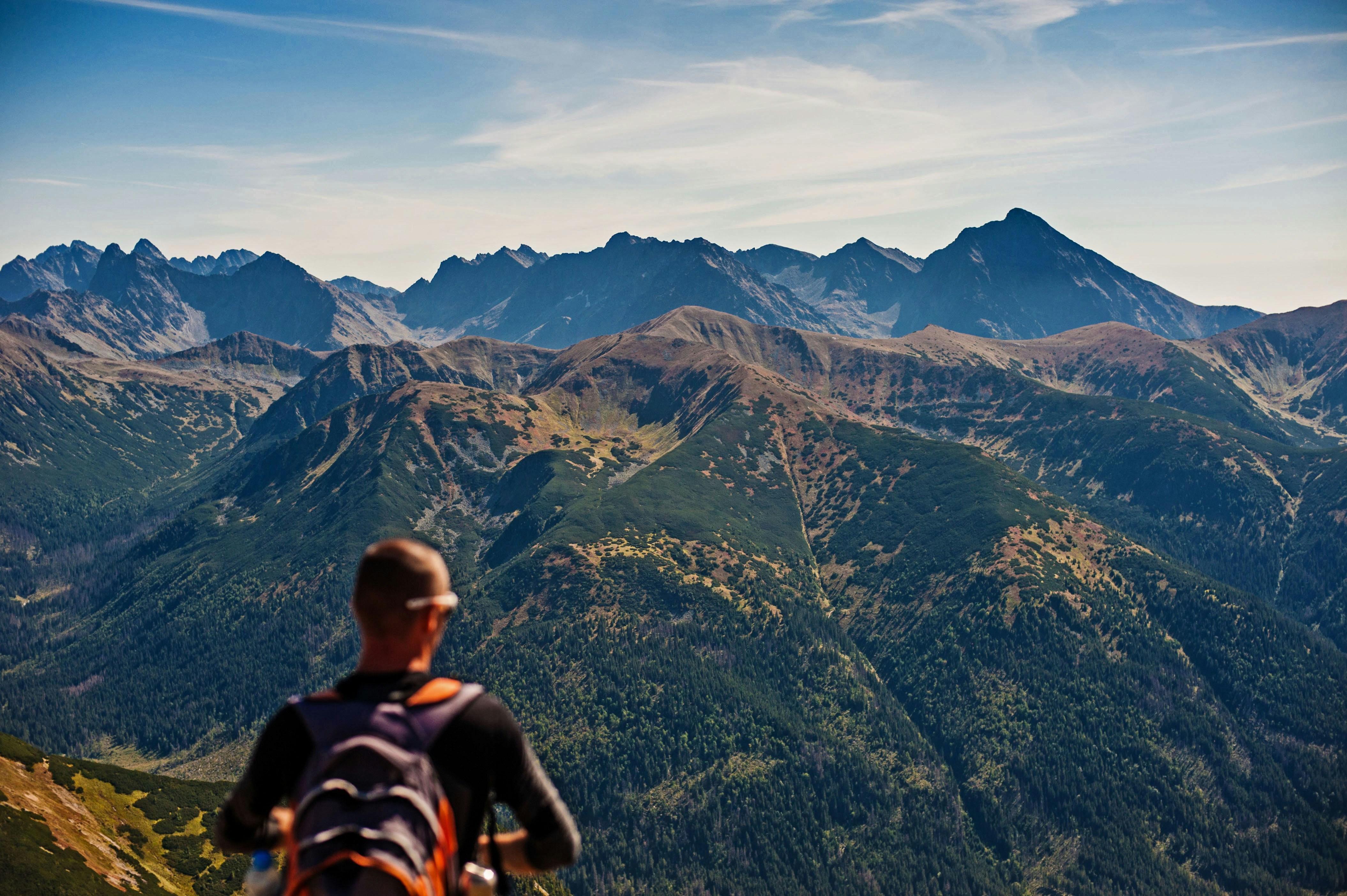 Hiker at the Edge: Ridge Line Voyages Under Alpine Dawn