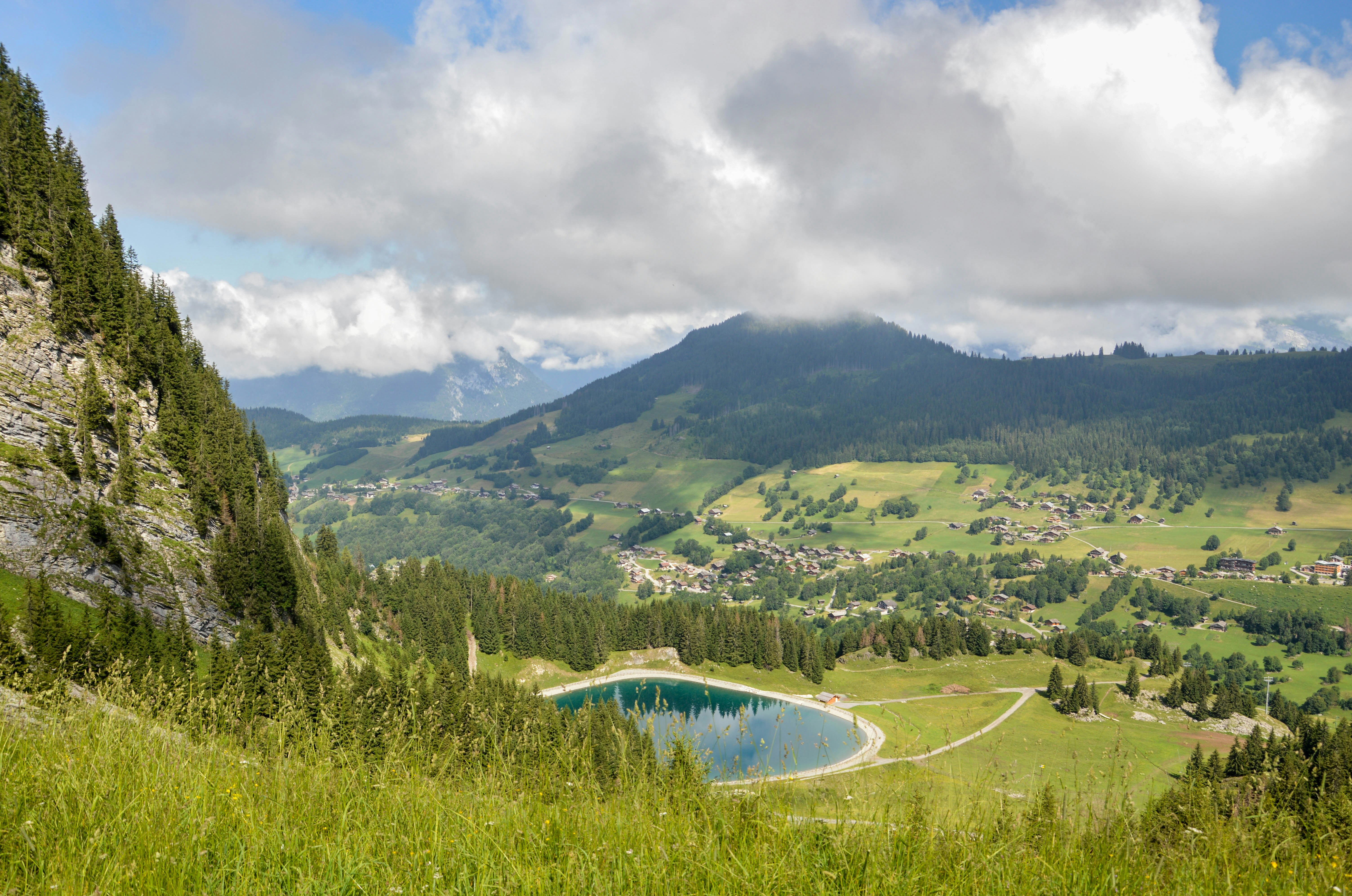 a lake in the middle of a lush green valley