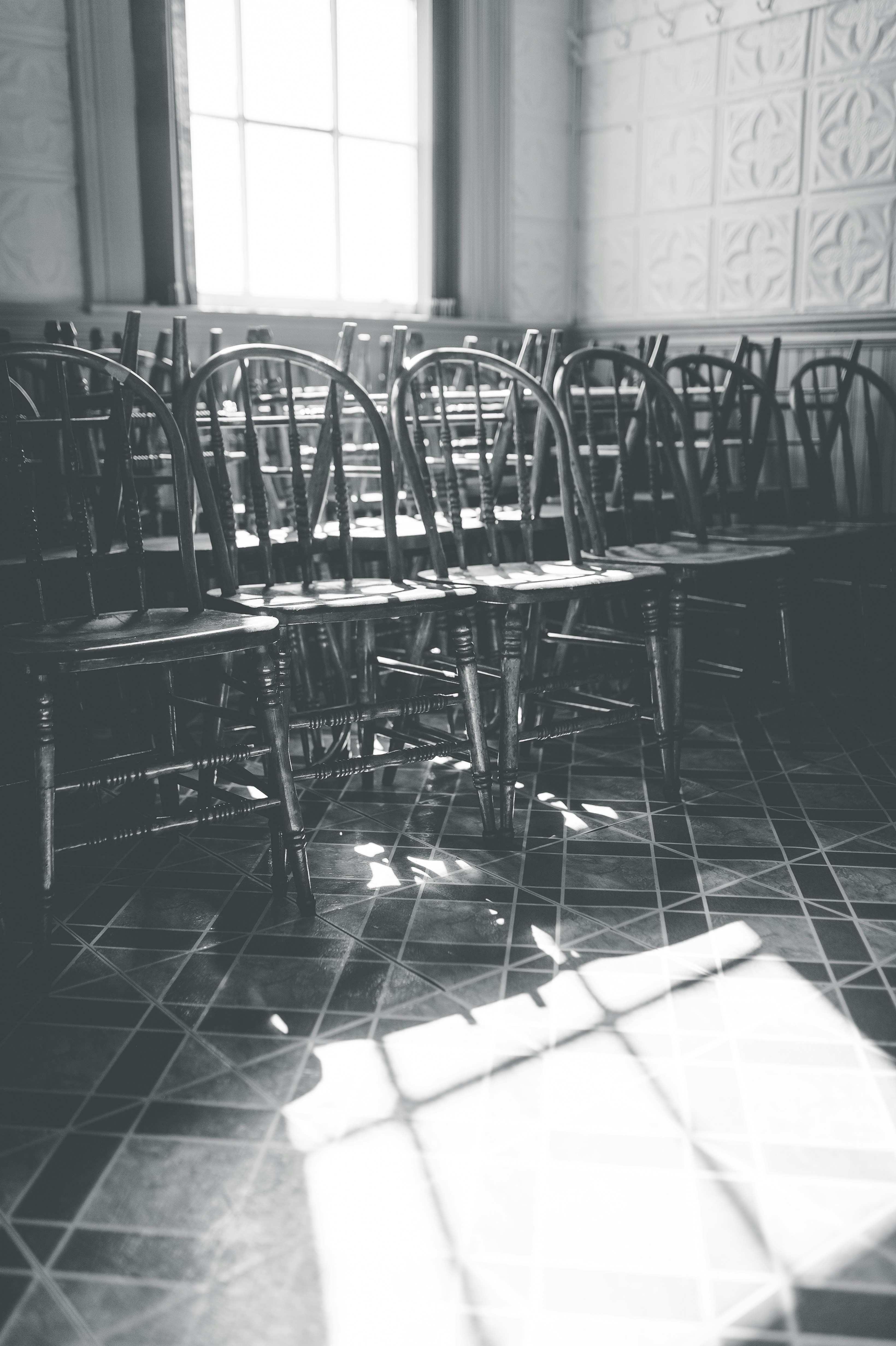 Sunlit Geometry: Empty Chairs in a Quiet Hall
