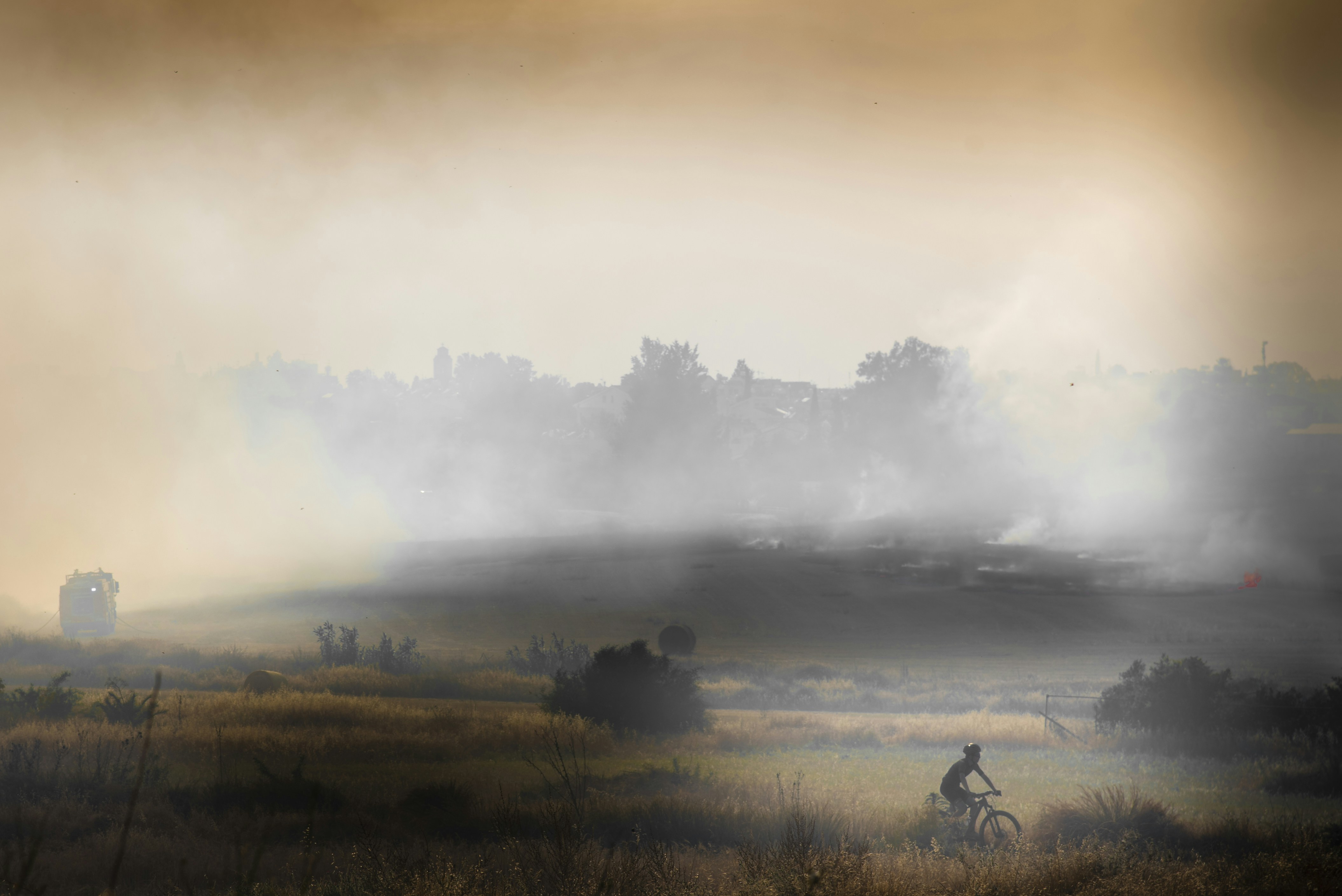 Cyclist Through a Smoke-Hazed Plain