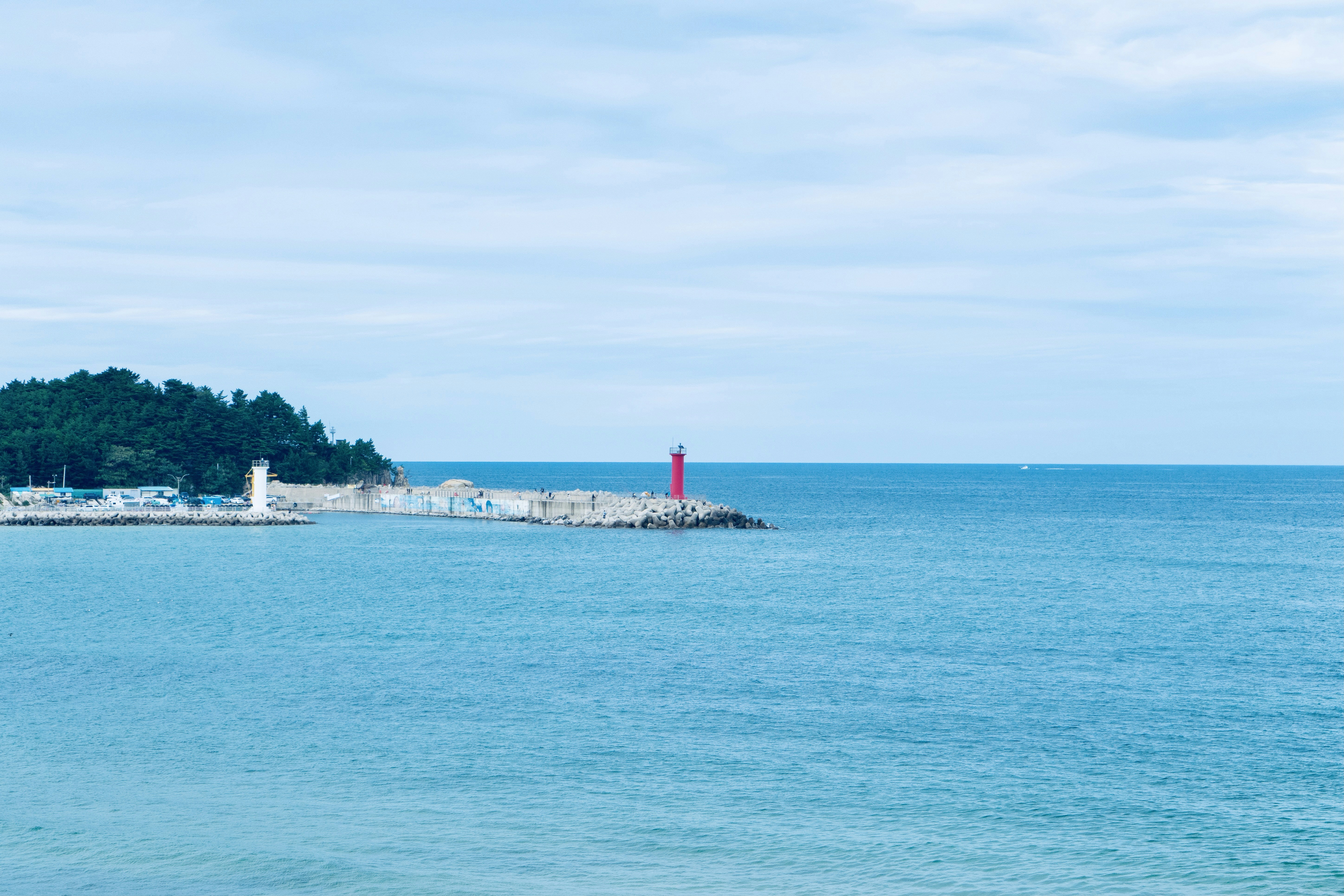 Crimson Lighthouse at the Quiet Breakwater