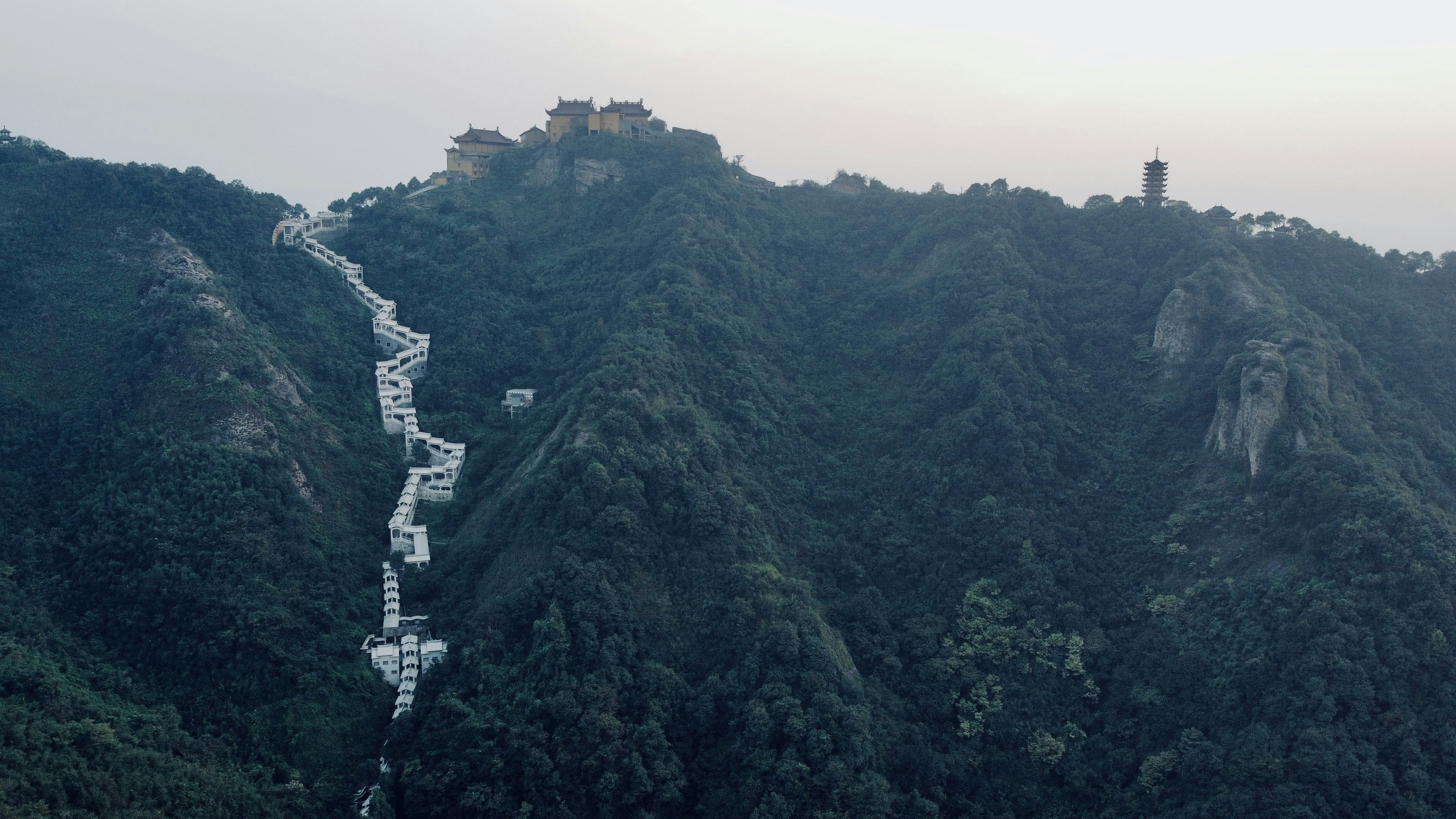 A very tall mountain with a very long road on top of it photo – Free ...