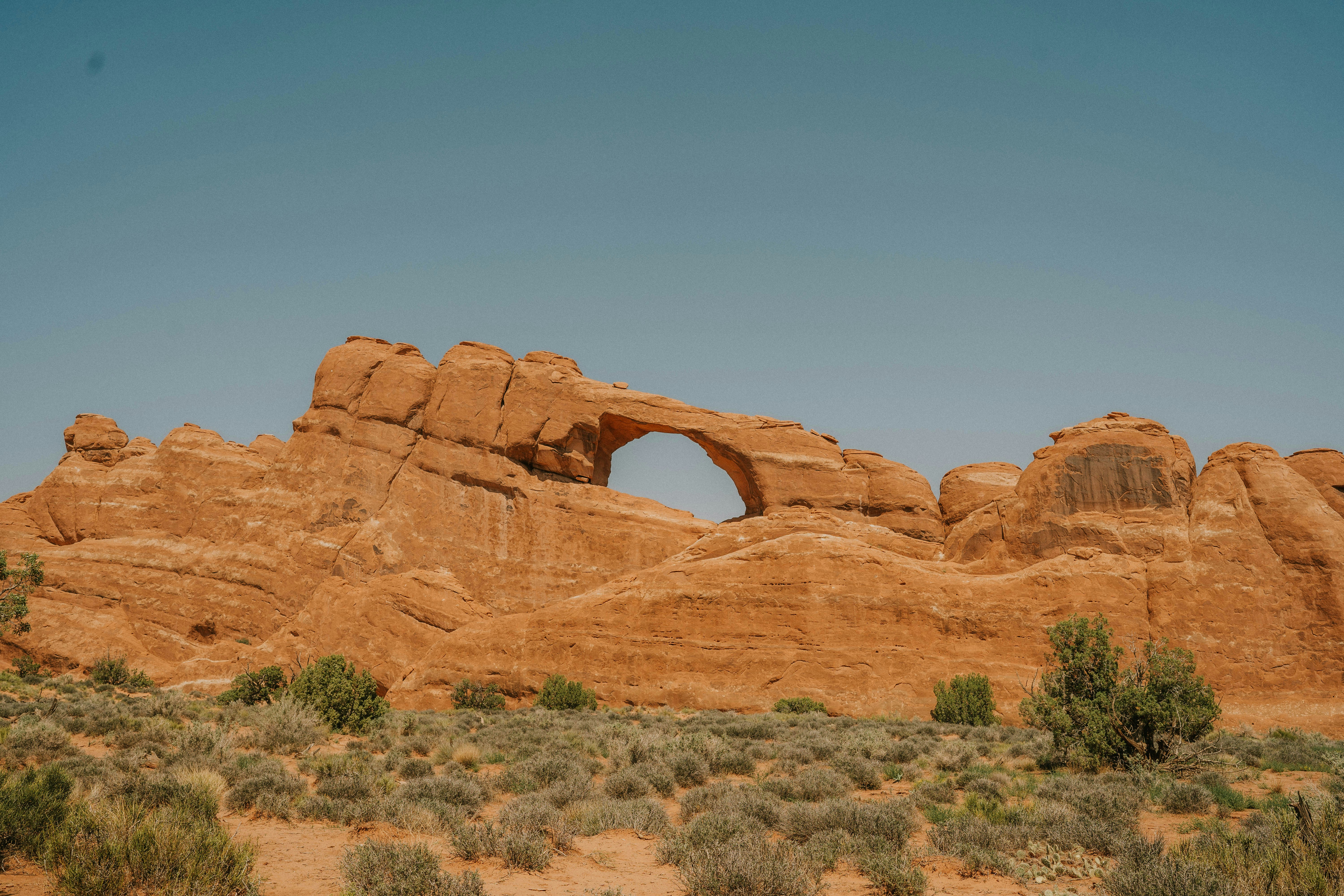 The Red Rock Arch: Desert Stone Bridge Framing the Sky
