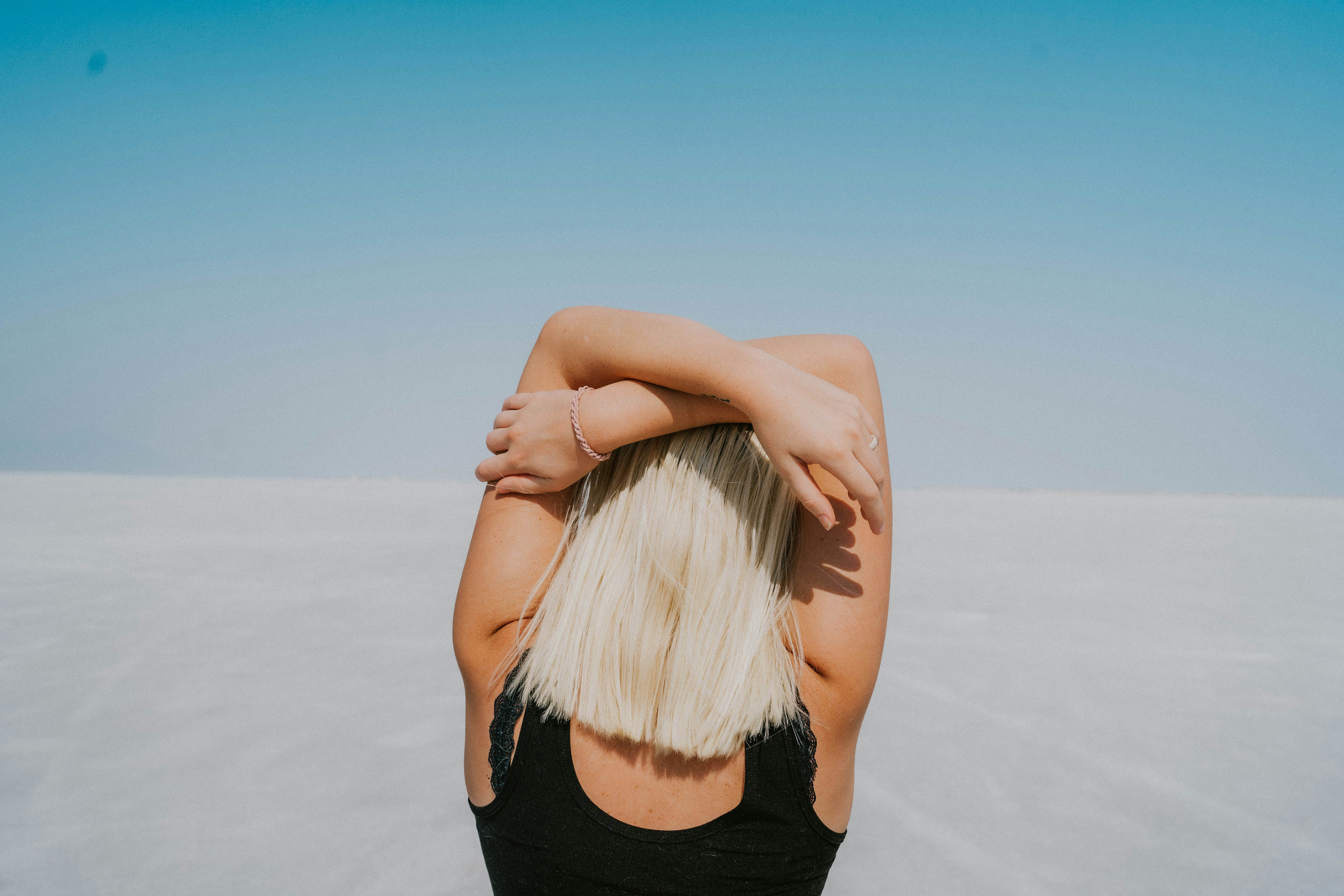 Back to the Sky: Blonde in a Black Tank on a Bleached Salt Plain
