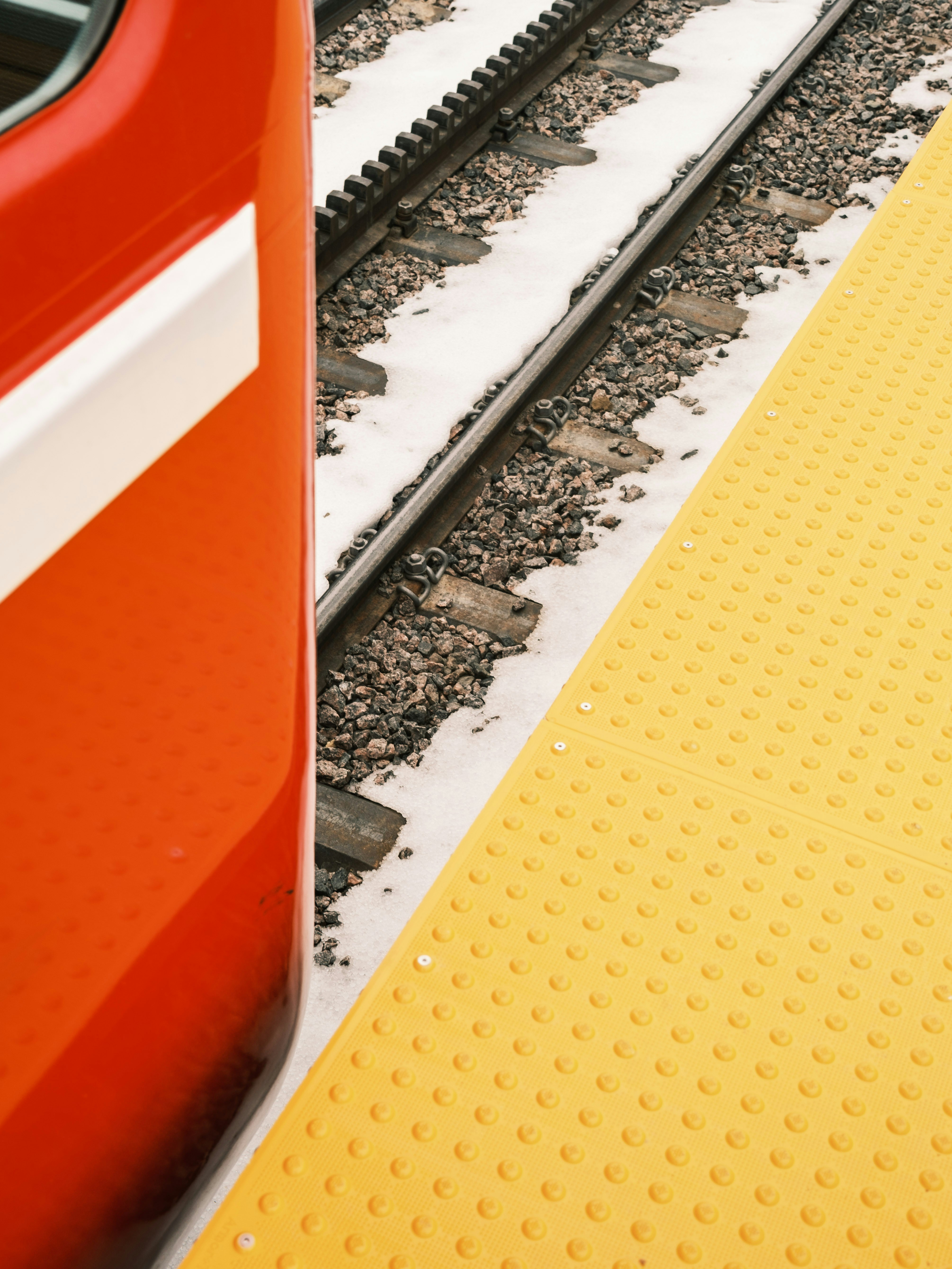 Edge of the Platform: Red Carriage Meets Yellow Tactile